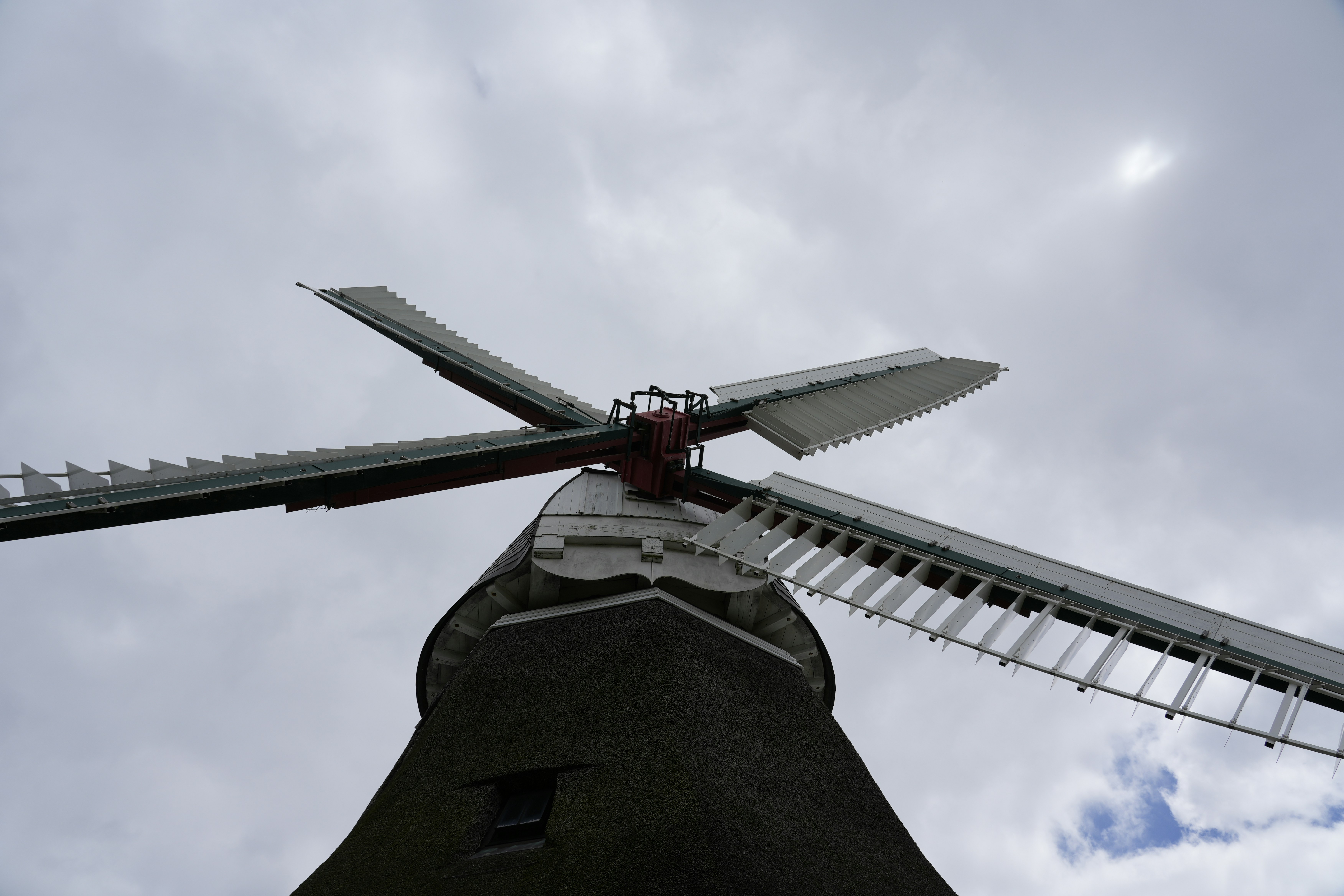 Upward Glimpse: The Windmill’s Silent Arms Reaching Skyward