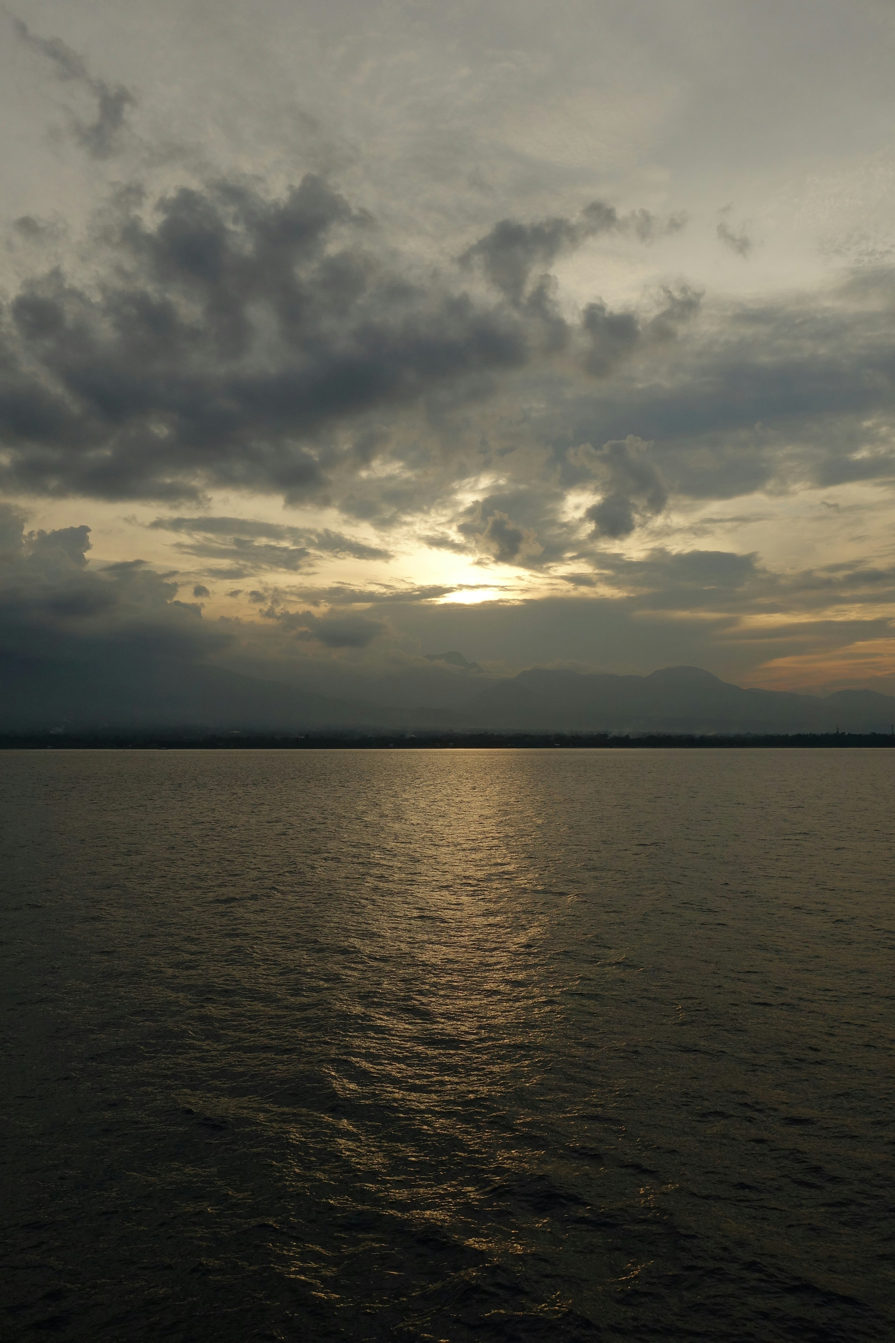 Sunlit Break in the Clouds Over a Quiet Horizon