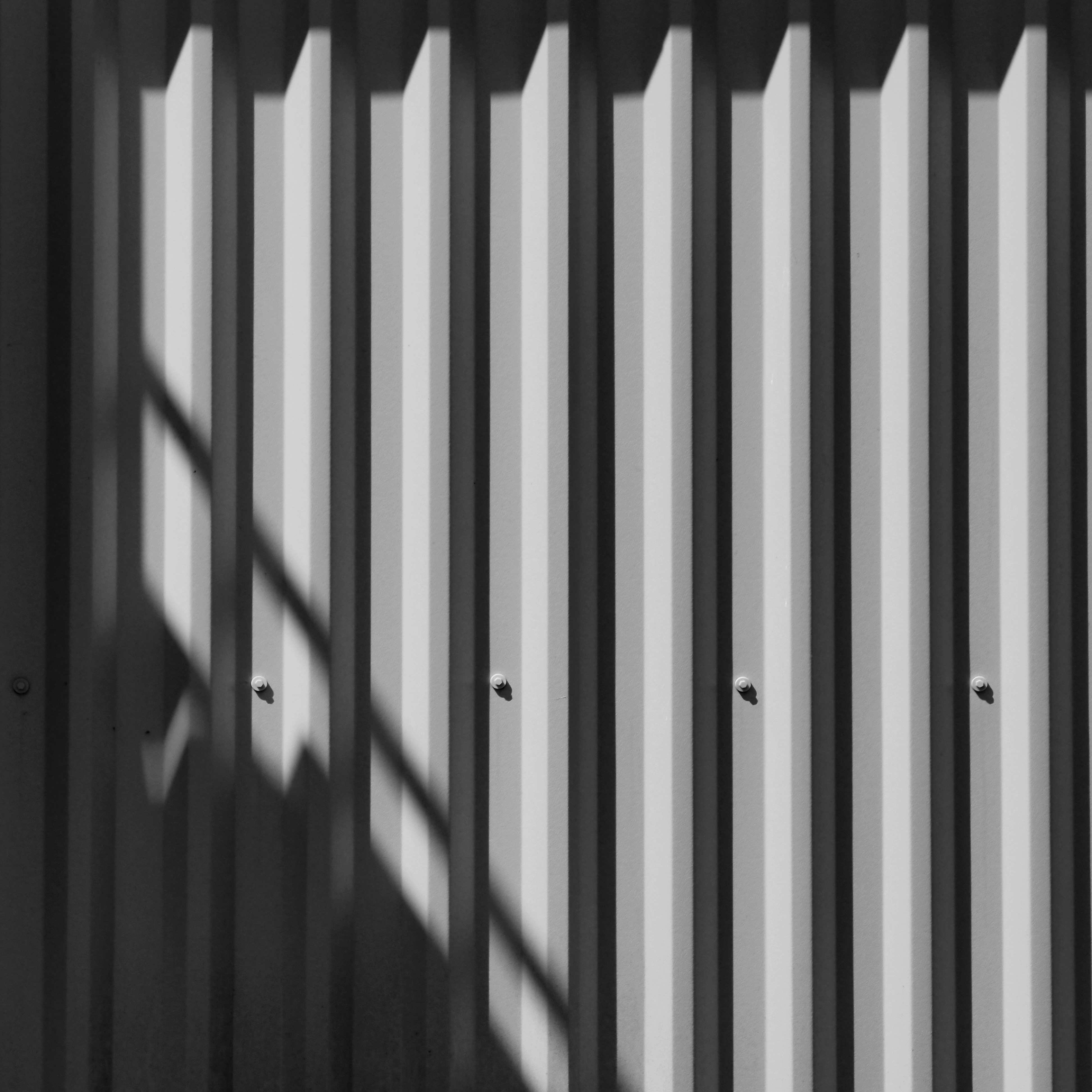 Shadowed Ribs: A Monochrome Play of Vertical Stripes and Diagonal Angles