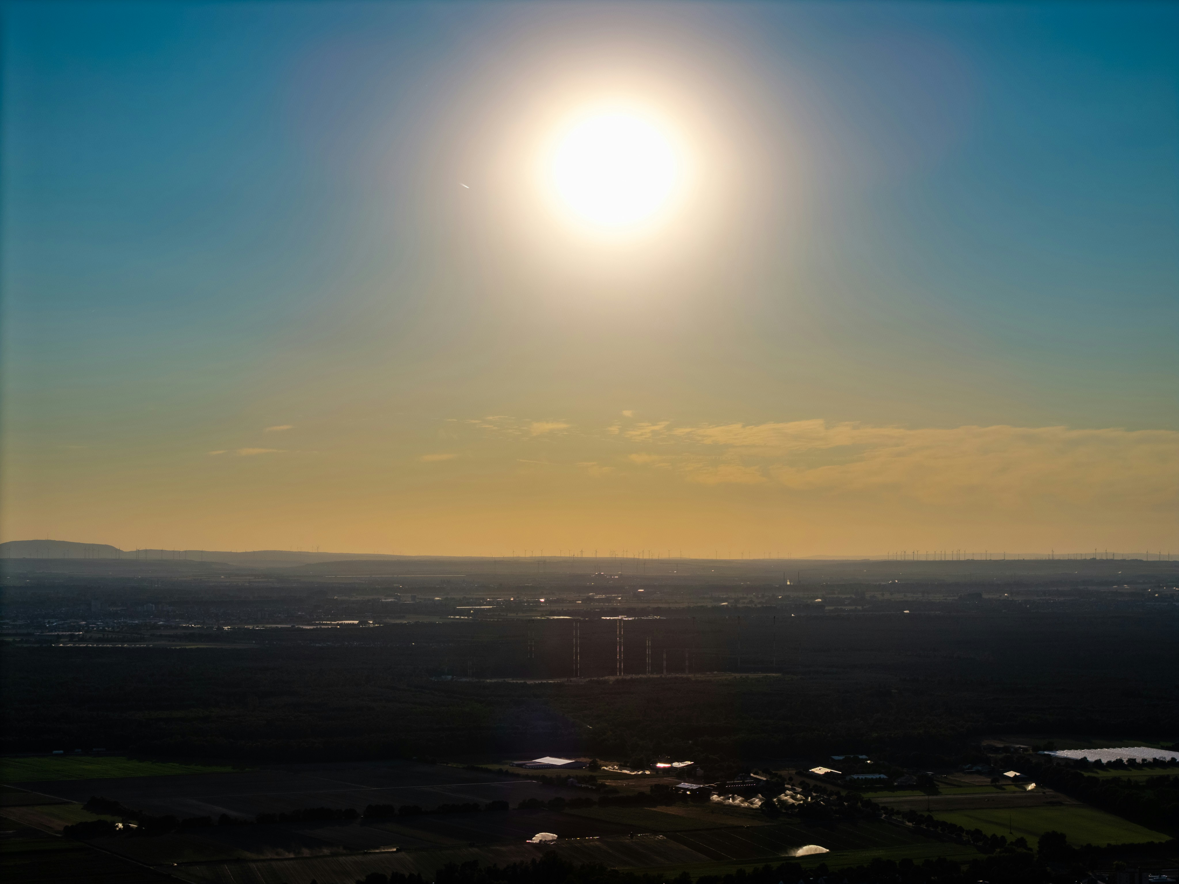 Low-Altitude Horizon: Sun, Sky, and Farmland beneath