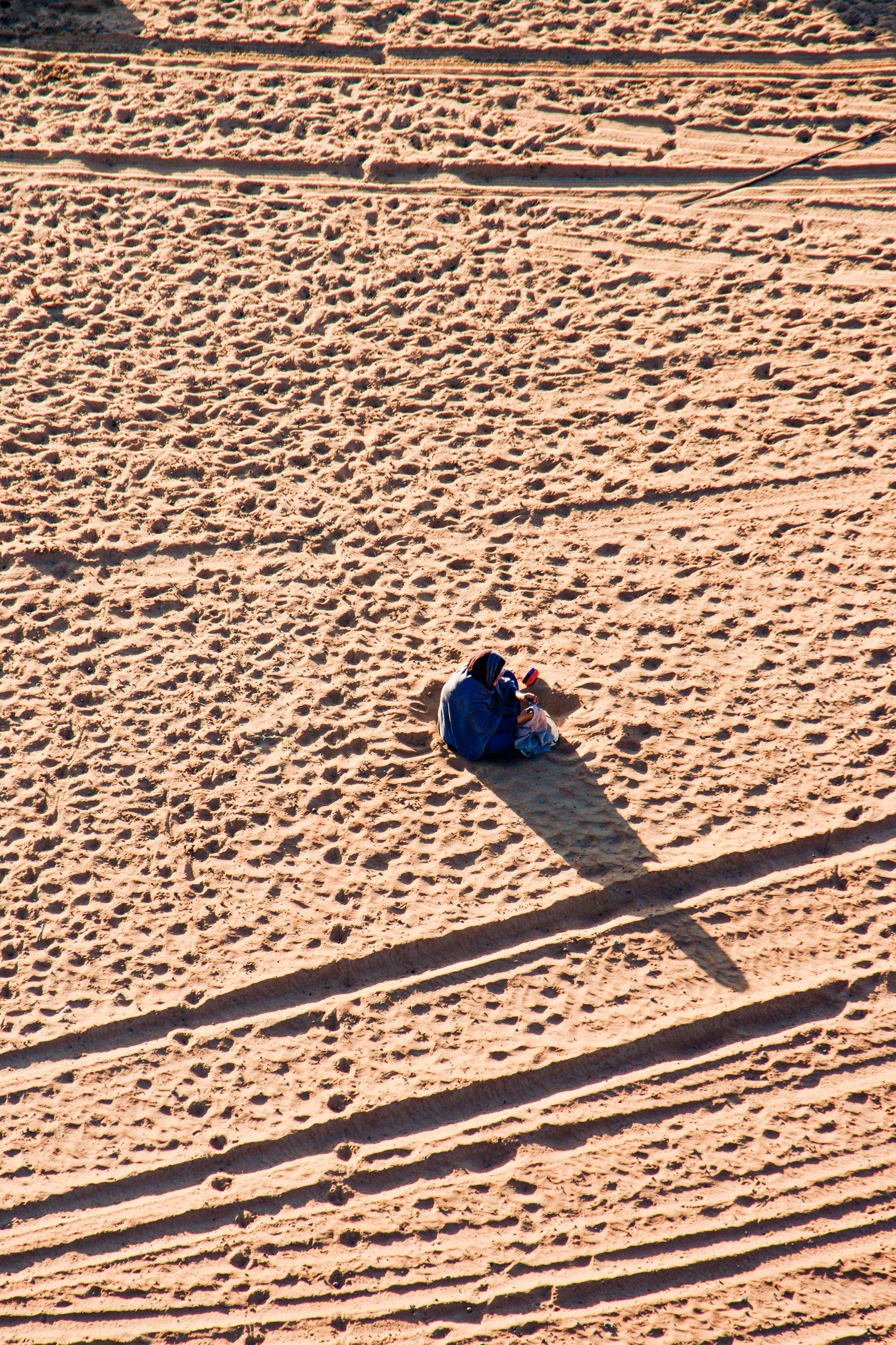 Solo Figure in Sand: A Quiet Moment Seen From Above