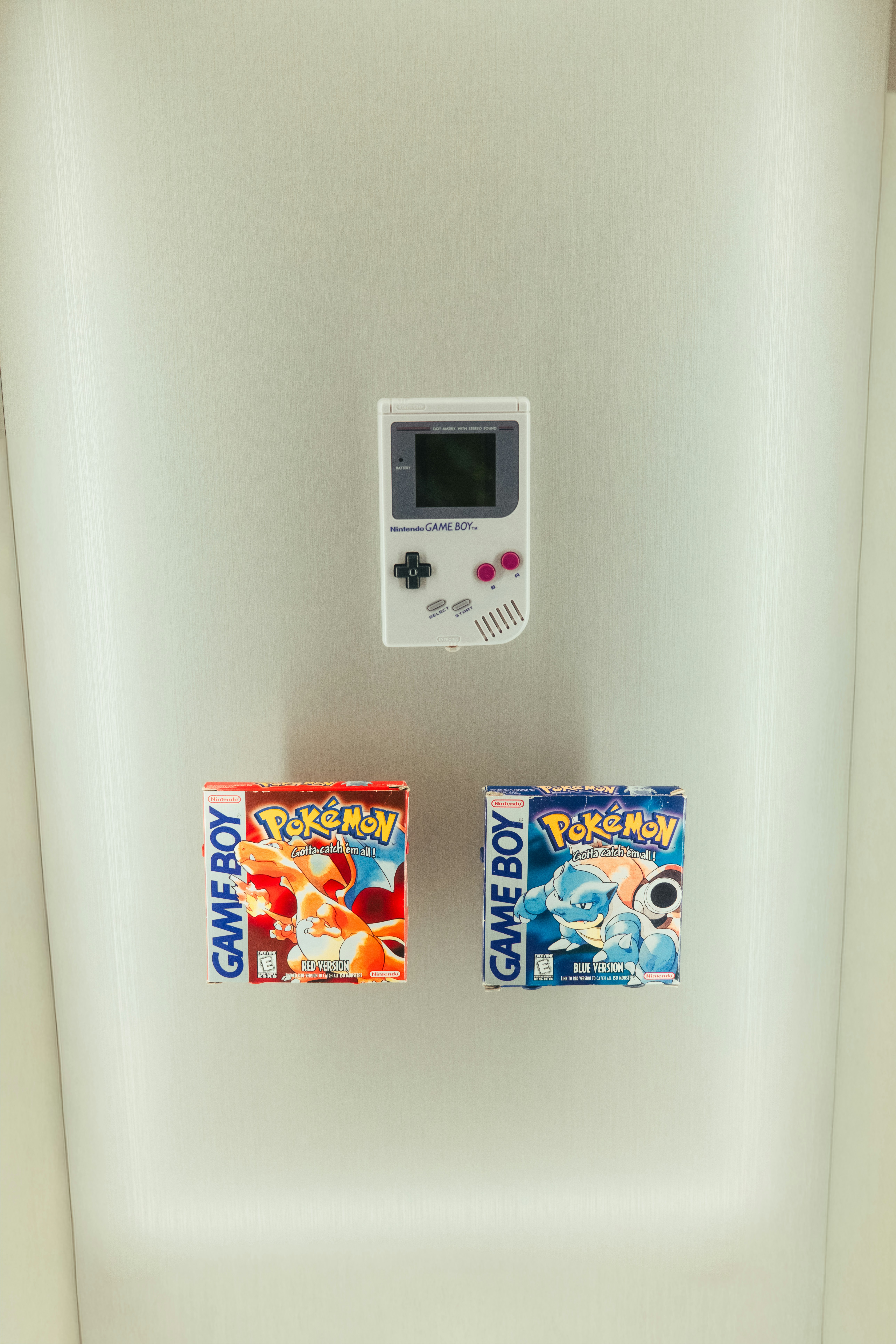 Game Boy Nostalgia: Two Pokemon Boxes on a Metallic Wall