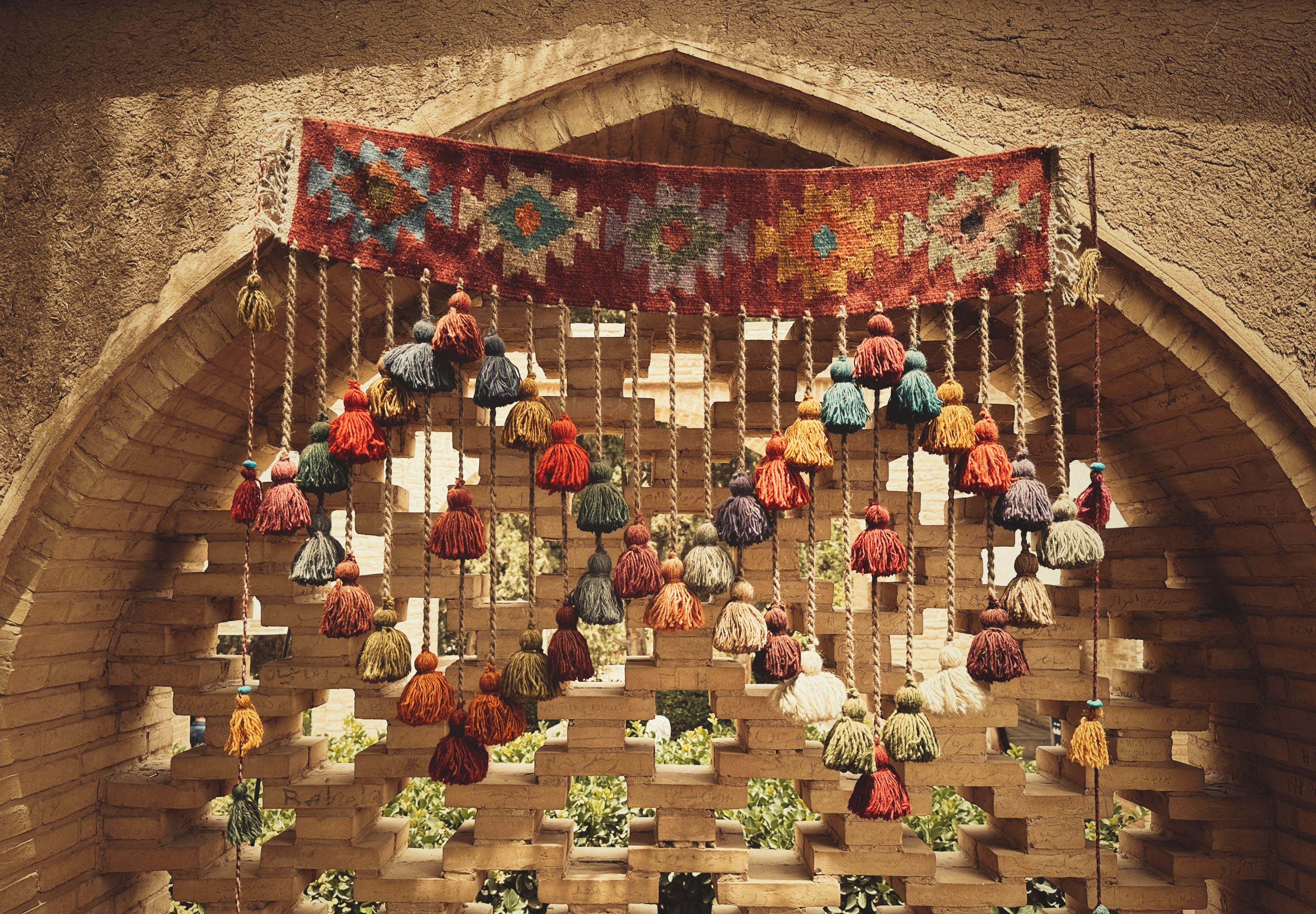 Tassels and Threads: A Crawl of Color across a Sacred Archway