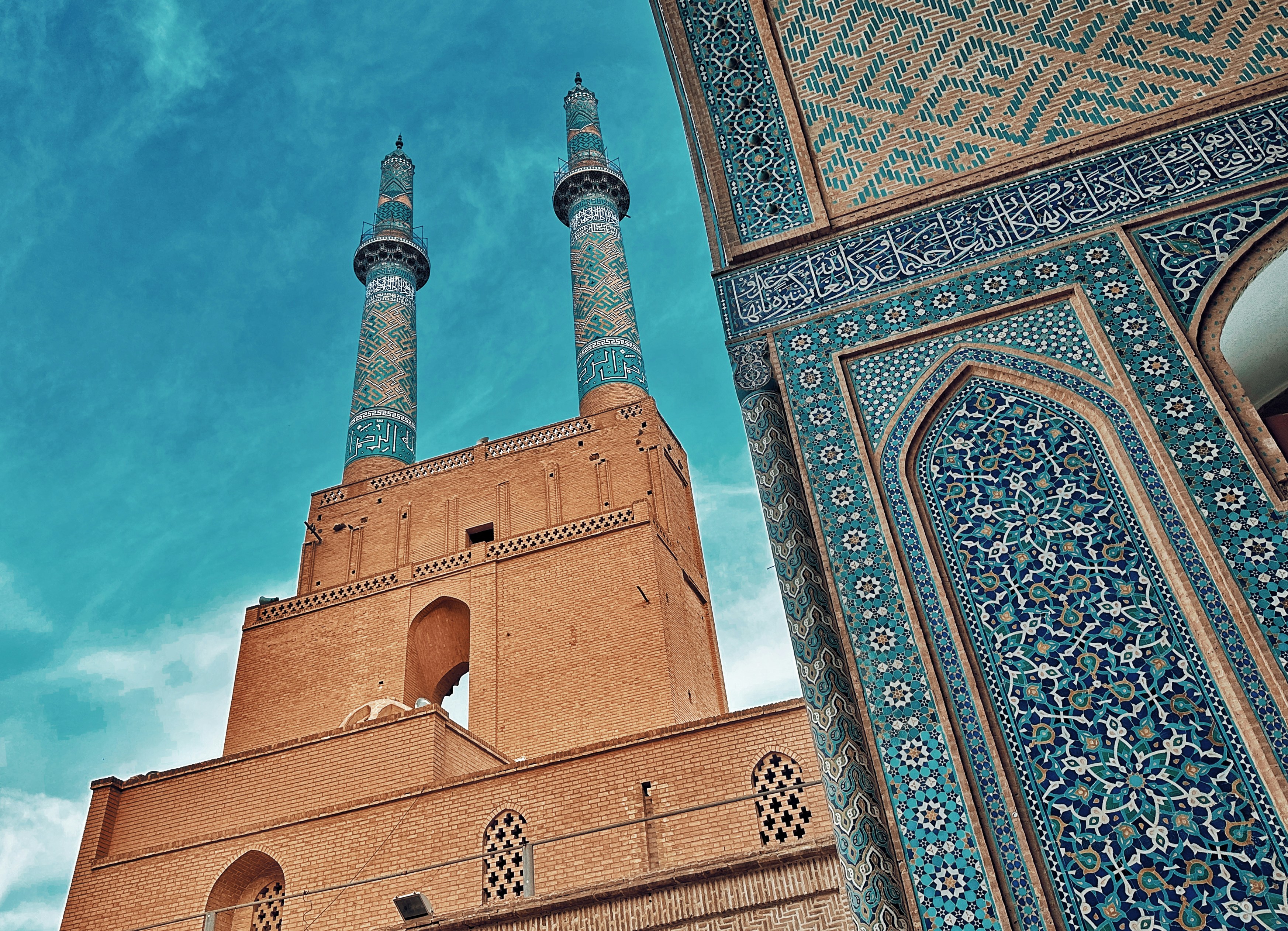 Blue Sky Domes: A Mosque Tower Rising Along Ornate Tilework