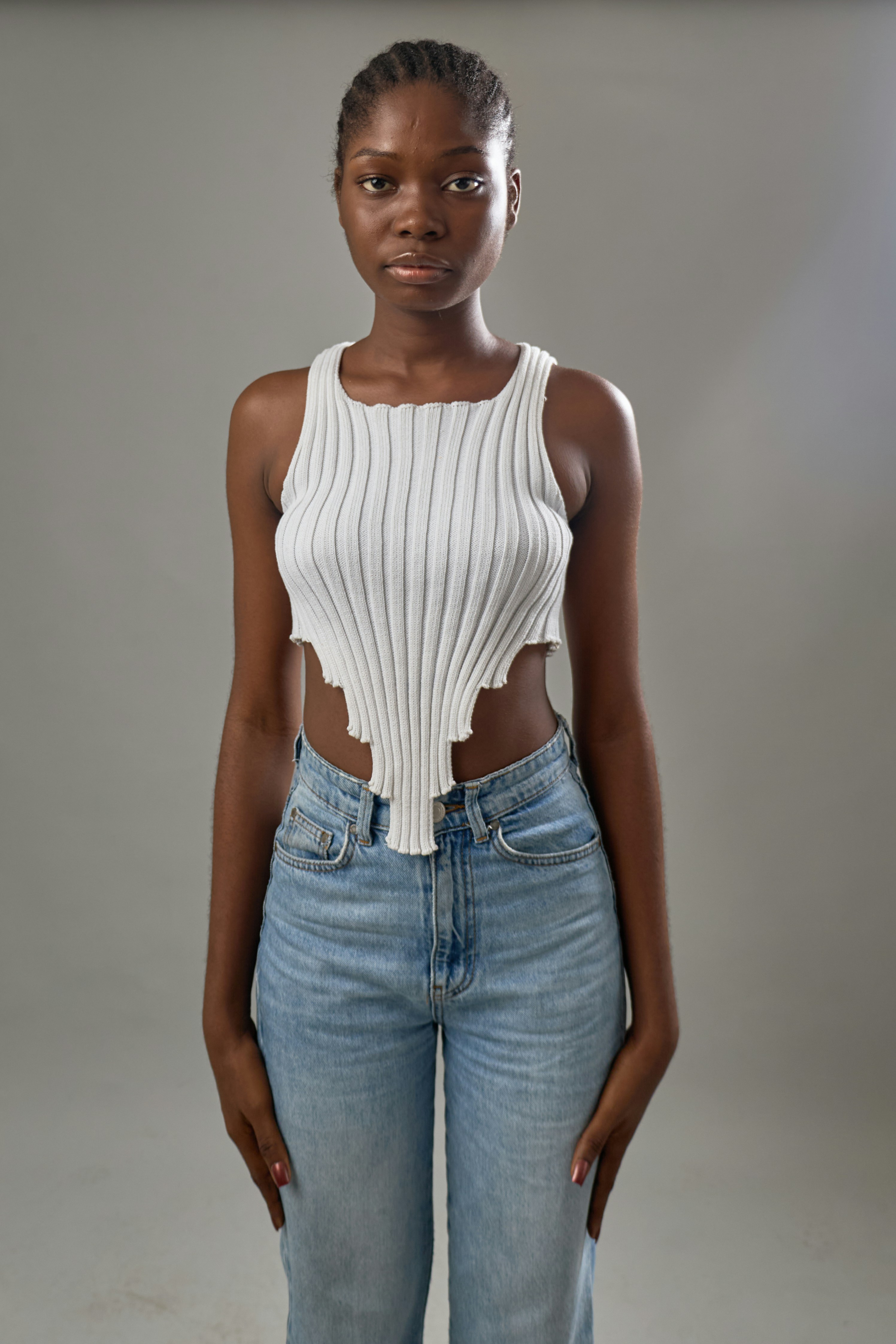 Centered Poise: A Studio Portrait of Confidence in White Ribbed Tank