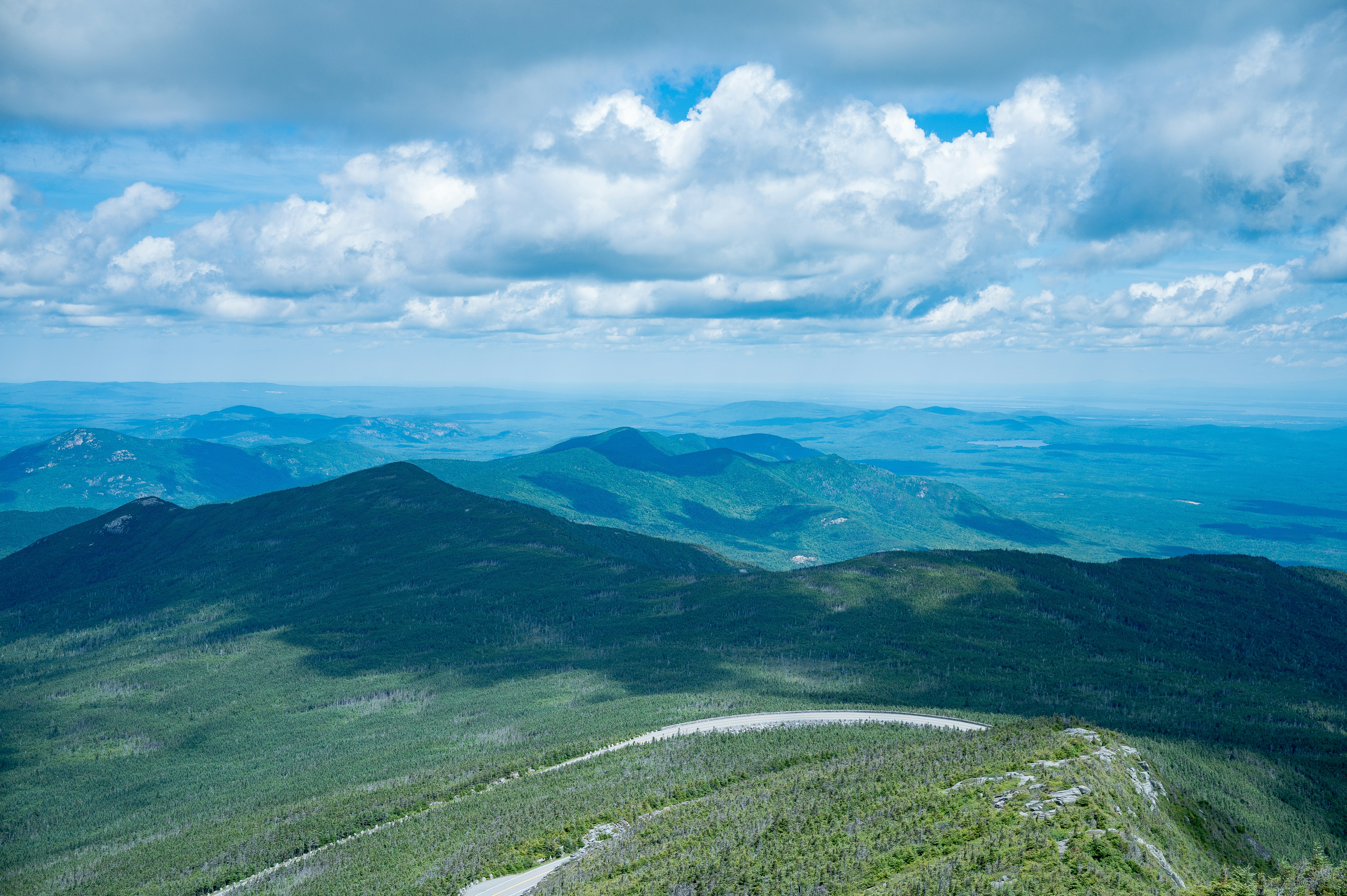 Aerial Summit: Rolling Green Ridges Beneath a Velvet Sky