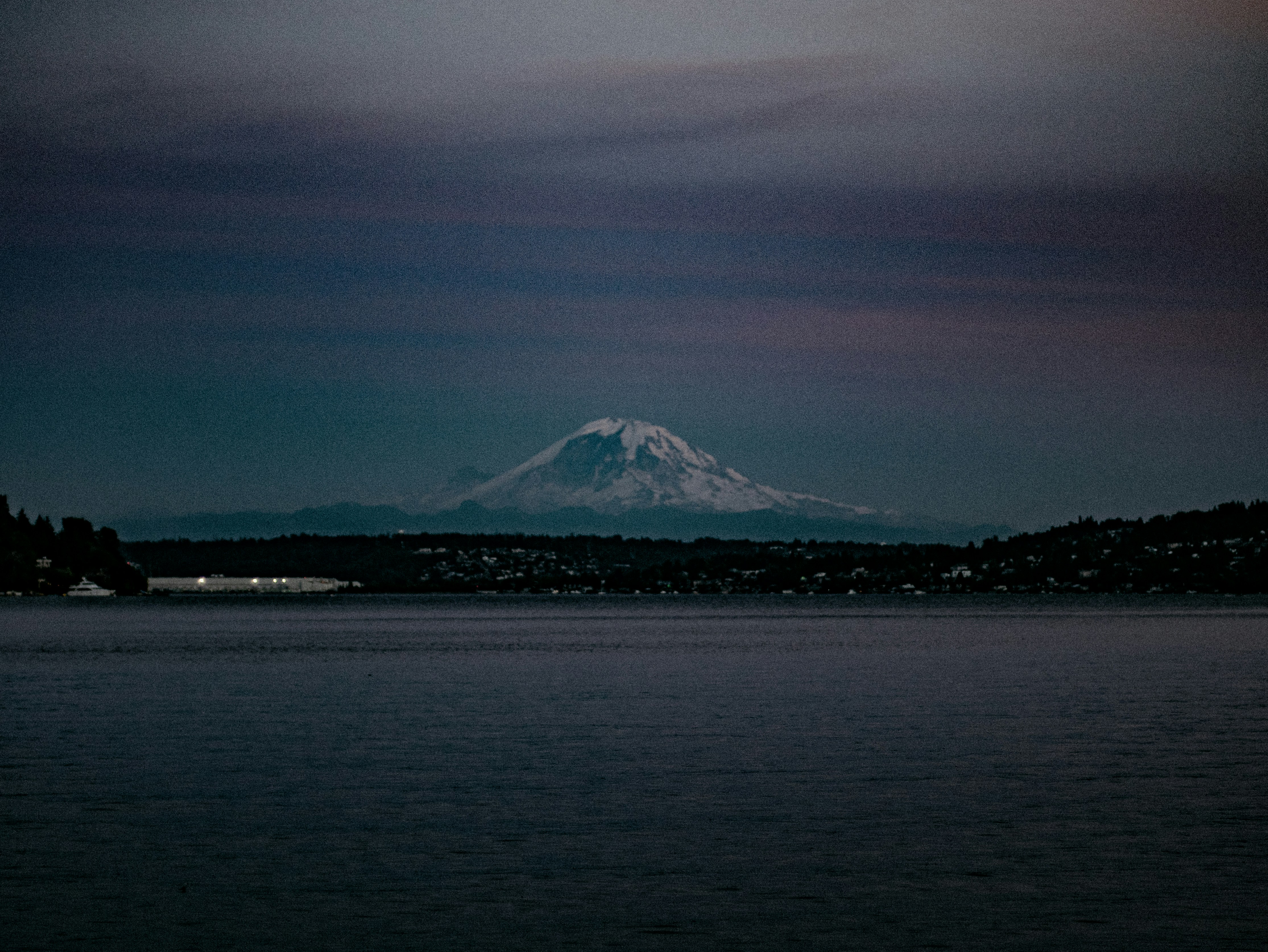 Snow-Capped Peak Rising Across a Quiet Fjord at Dusk