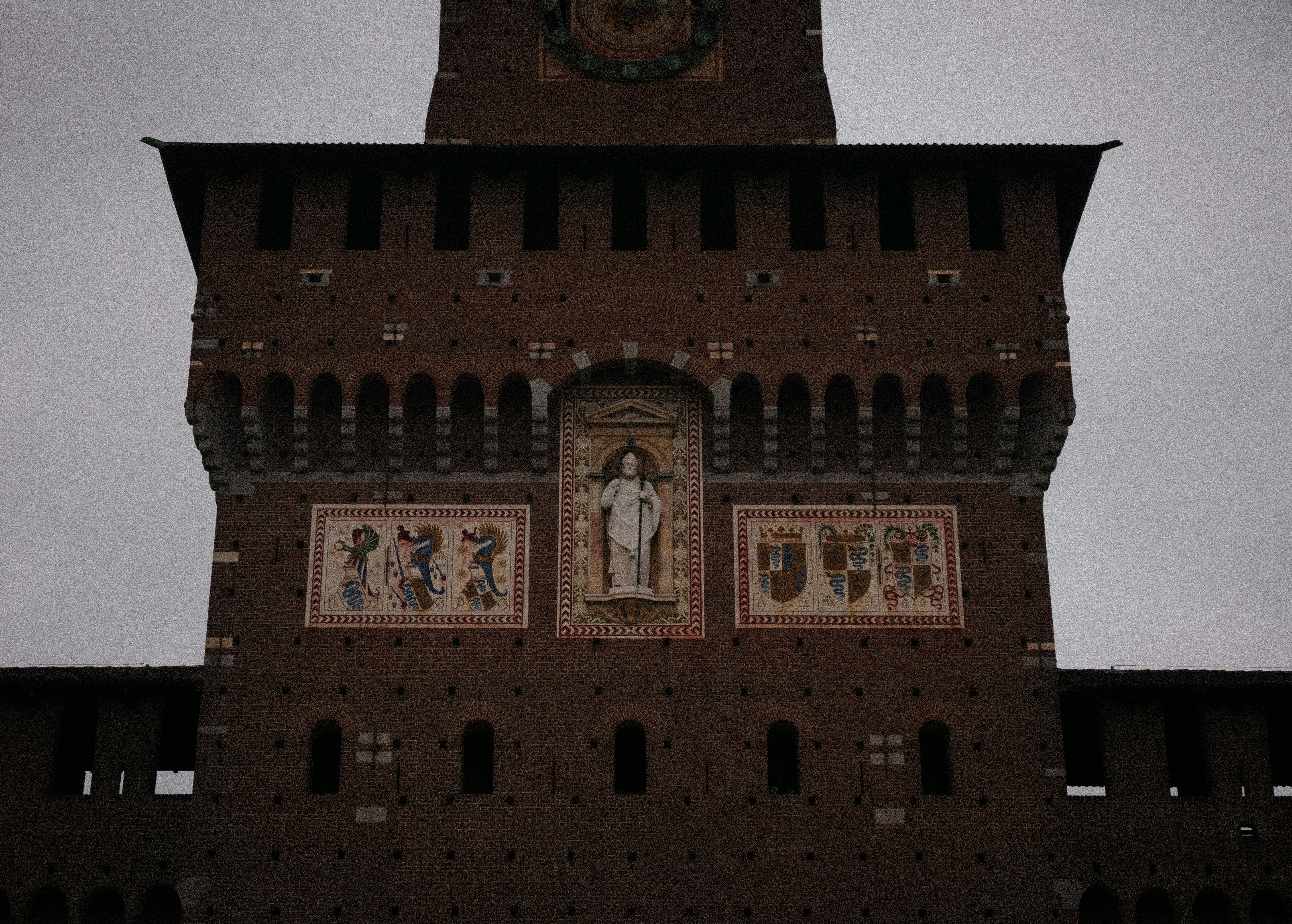 Brick Turret Portrait: Crest and Mosaic On an Ancient Facade
