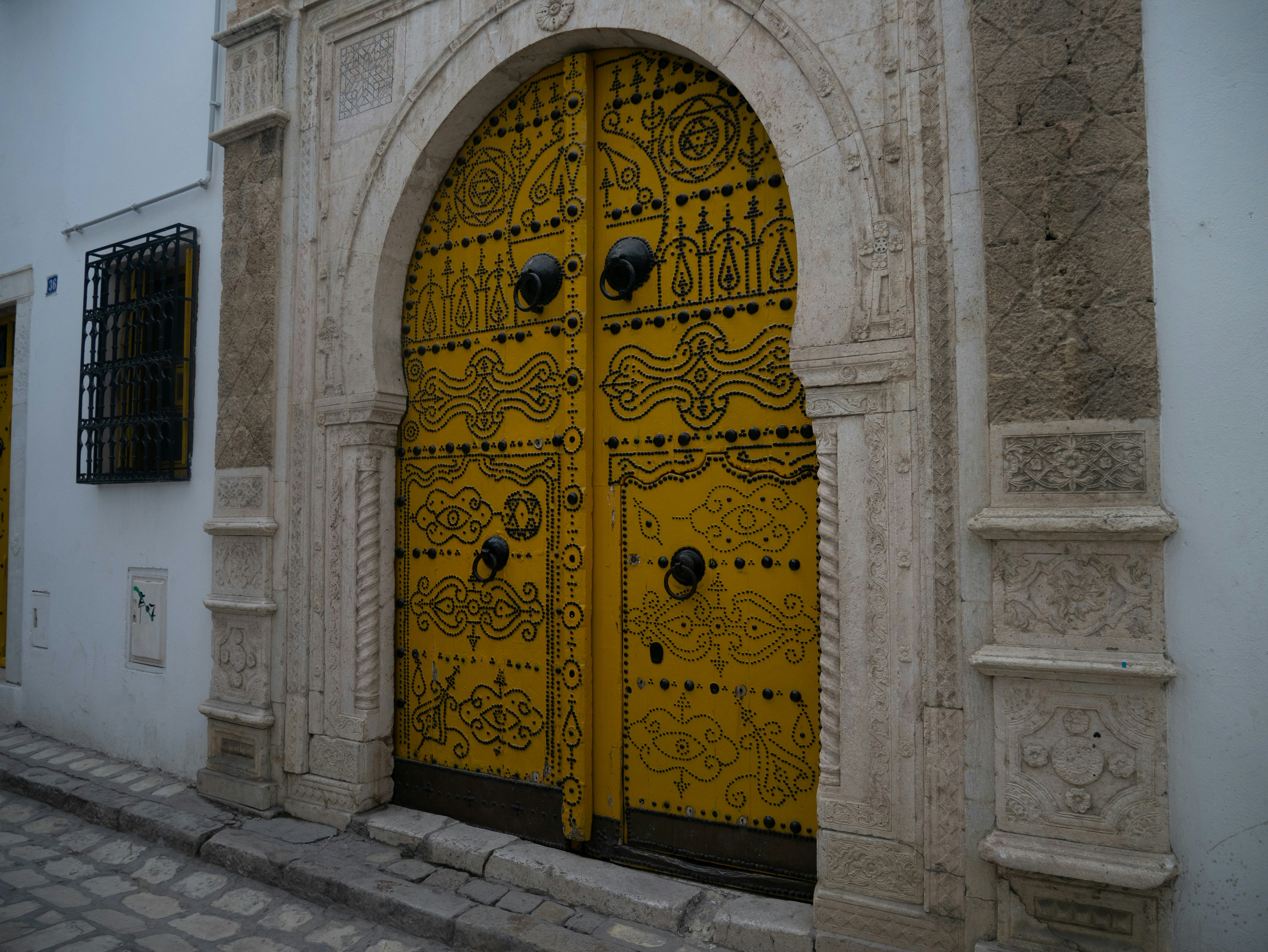 Golden Gate: Intricate Doors Framed by Carved Stone