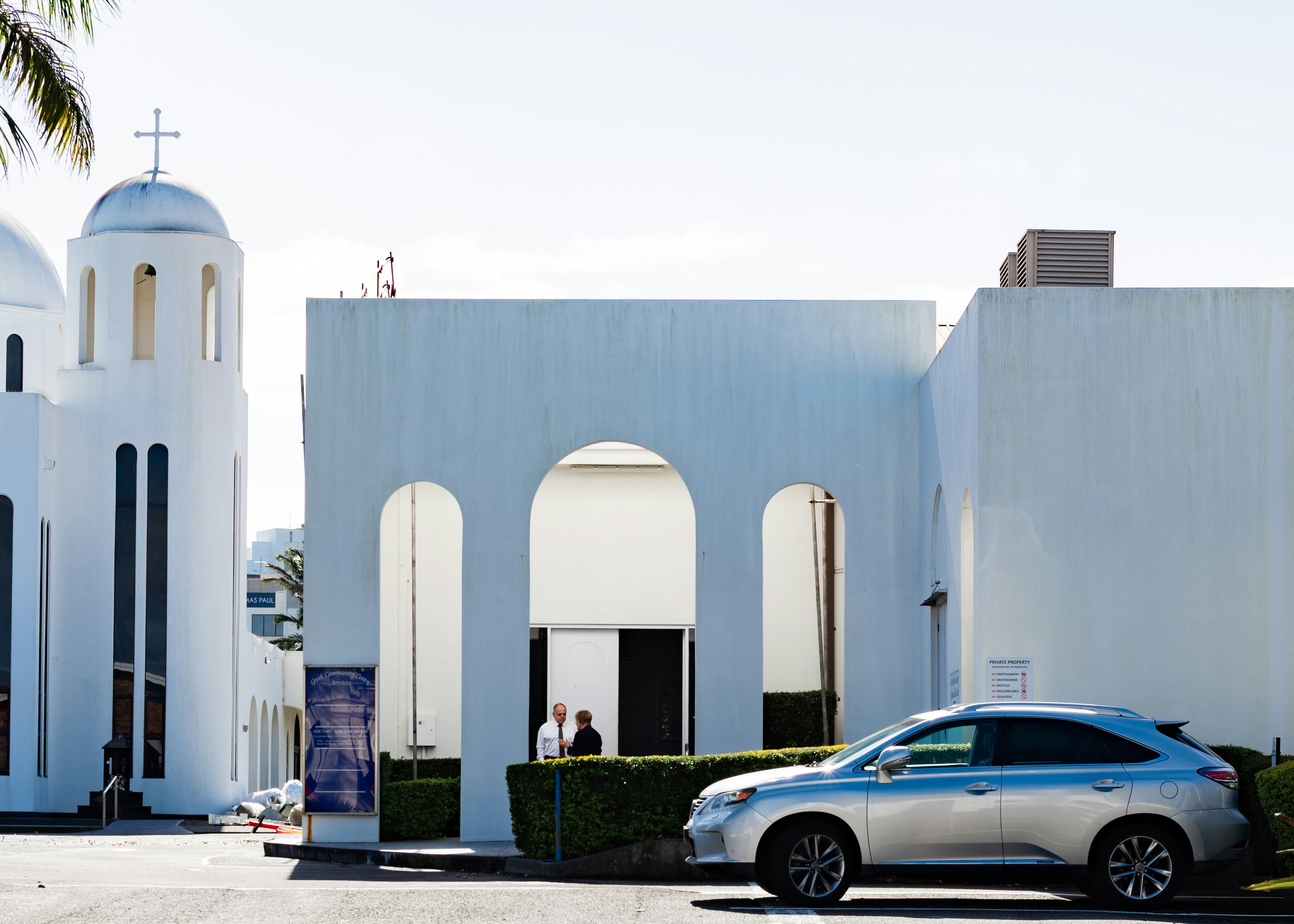 Blue Dome and Modern Archways: A Quiet Corner of the Cliffside Church