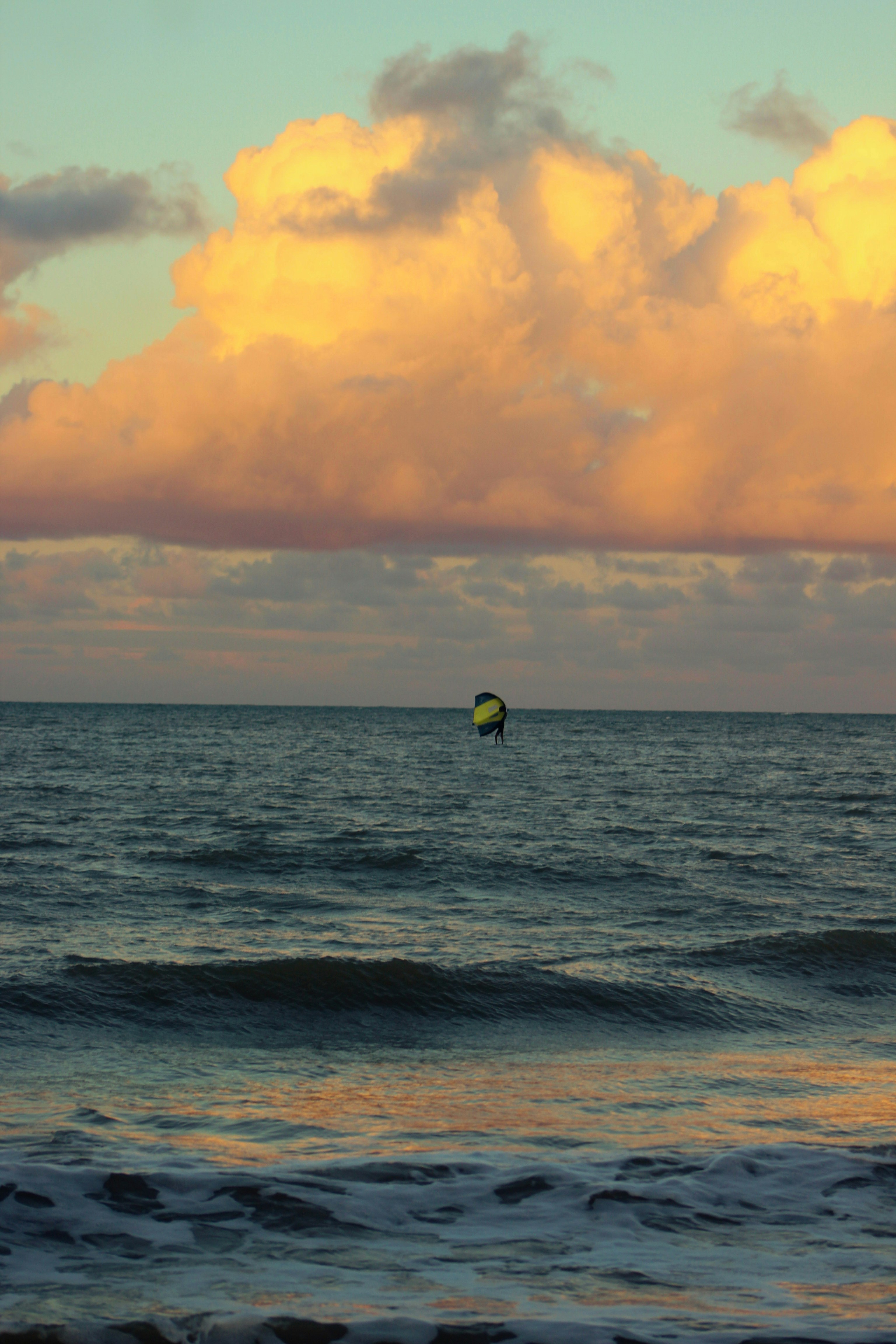 Quiet Horizon: A Windswept Sail Above the Calm