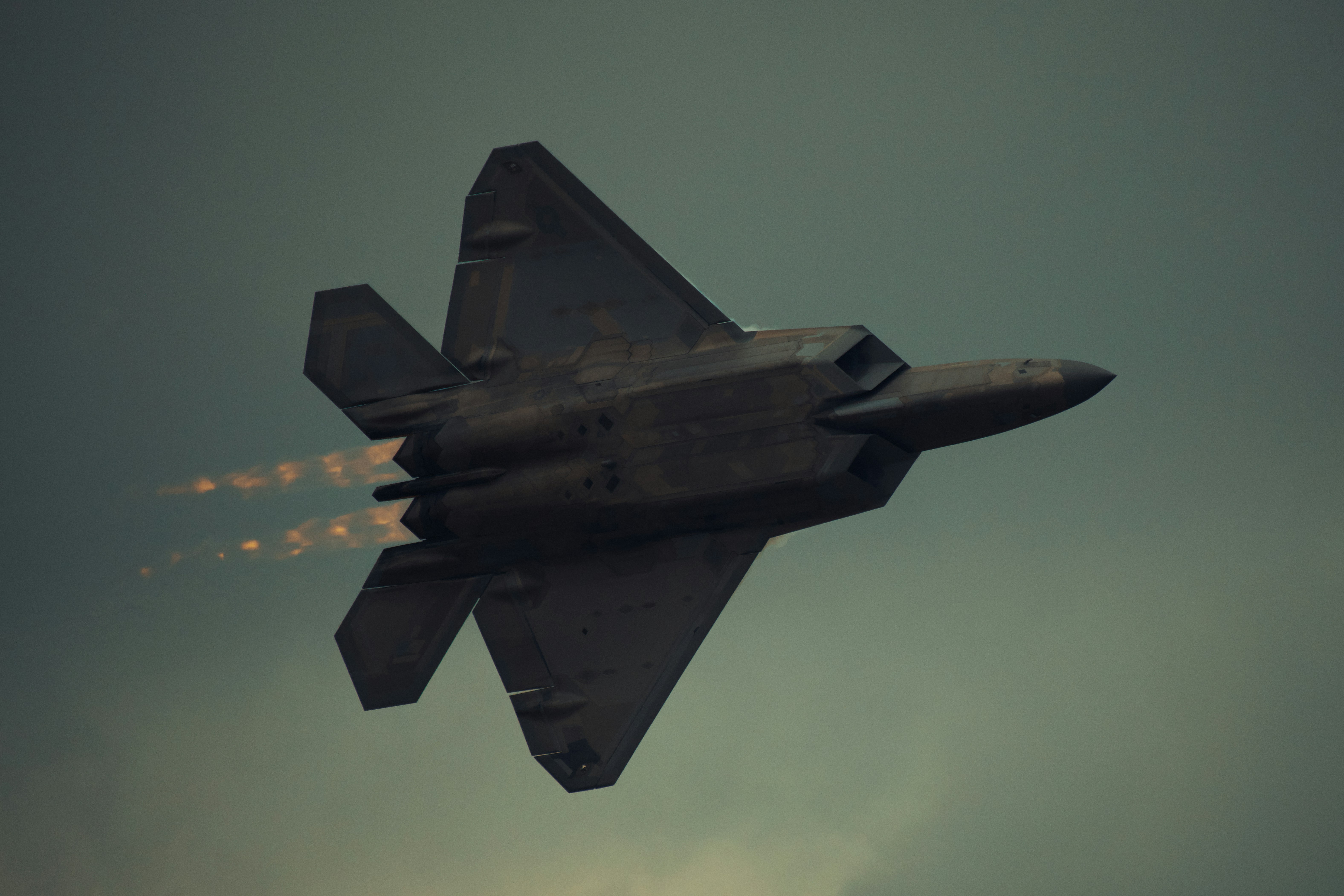 Midair silhouette: a lone fighter cuts through dusky sky