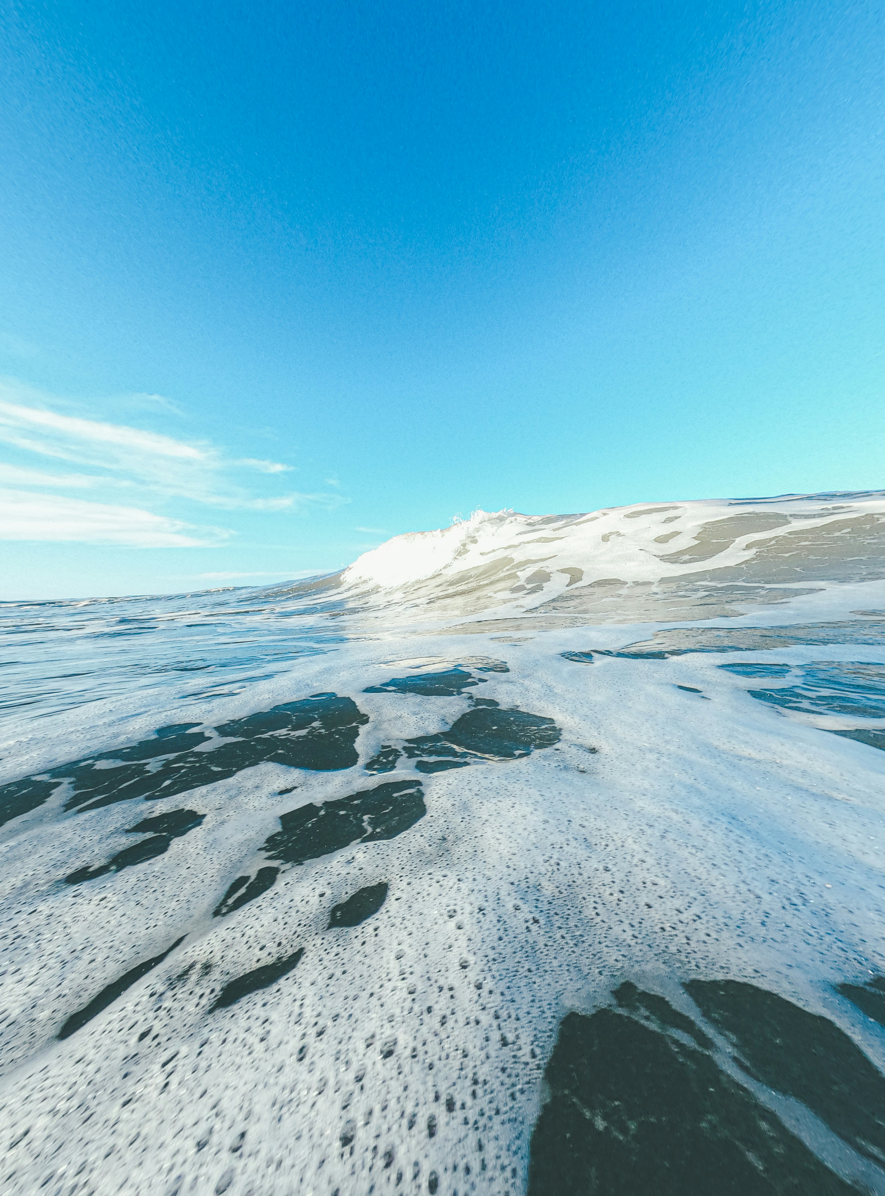 Sierra of Ice: A Cresting Wave Under a Clear Arctic Sky