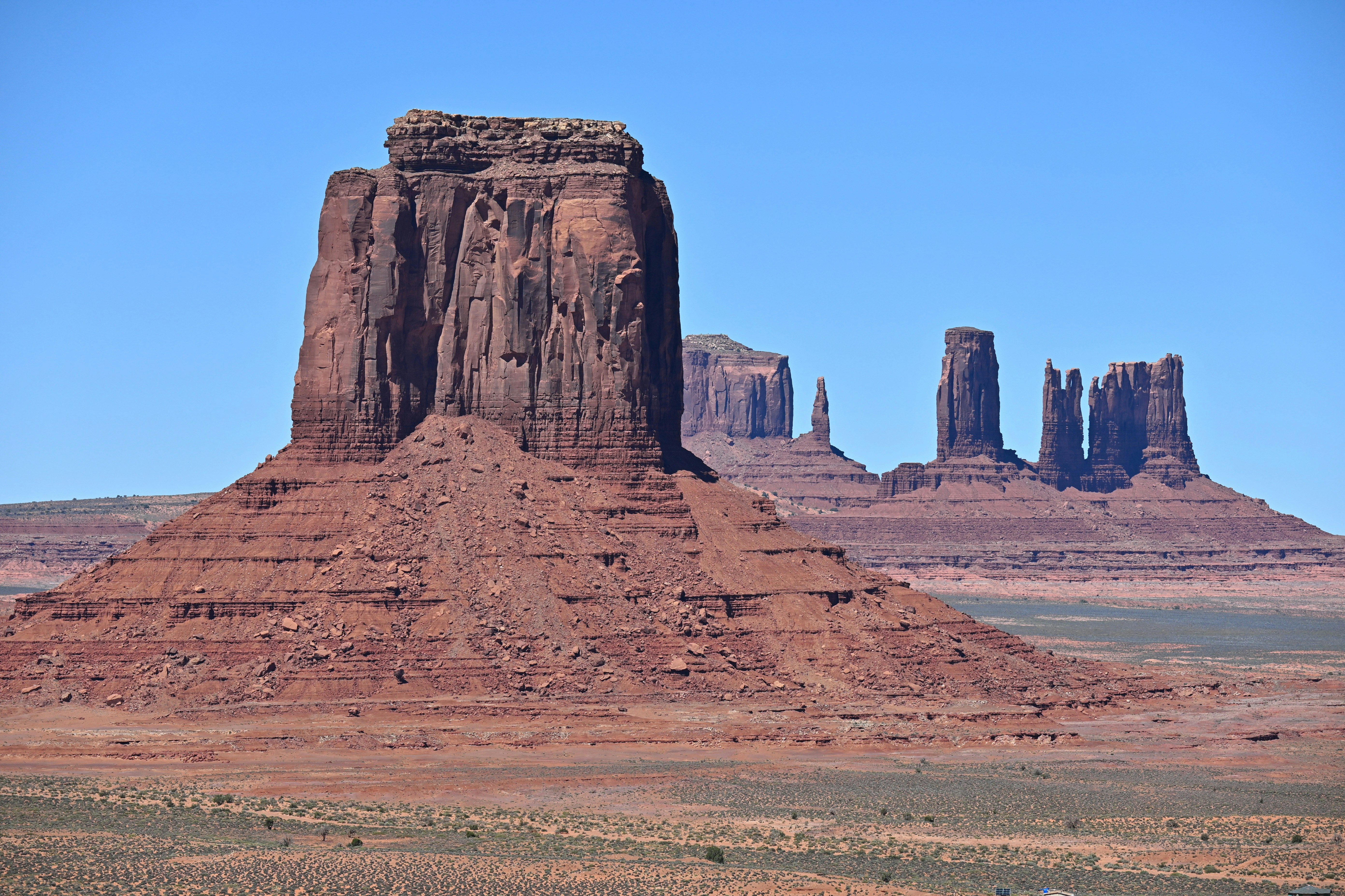 Desert Giants: The Monument Valley Plateaus Beneath a Clear Blue Sky