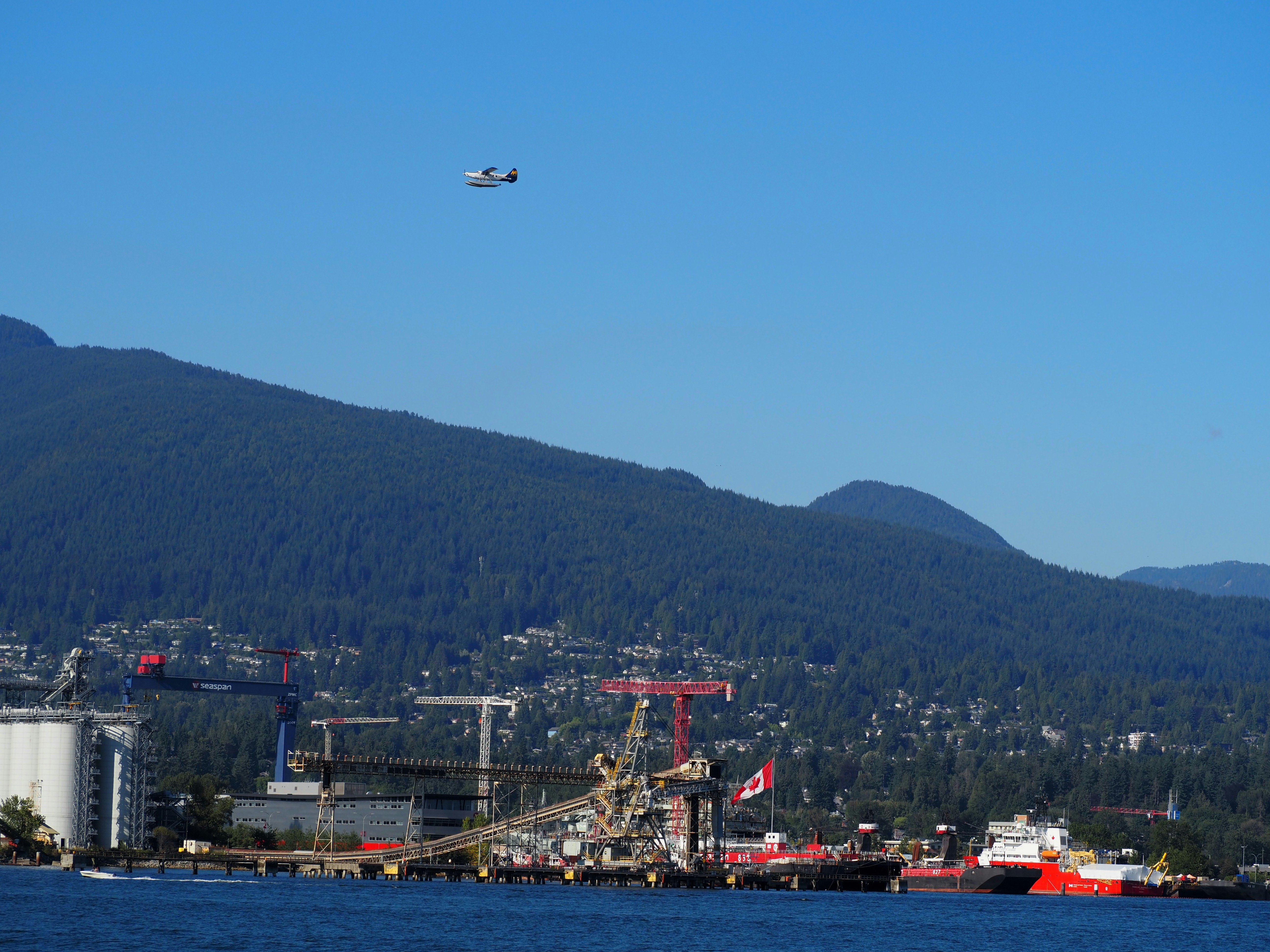 Helicopter Above Coastal Shipyard at Dusk–Blue Ridge Backdrop