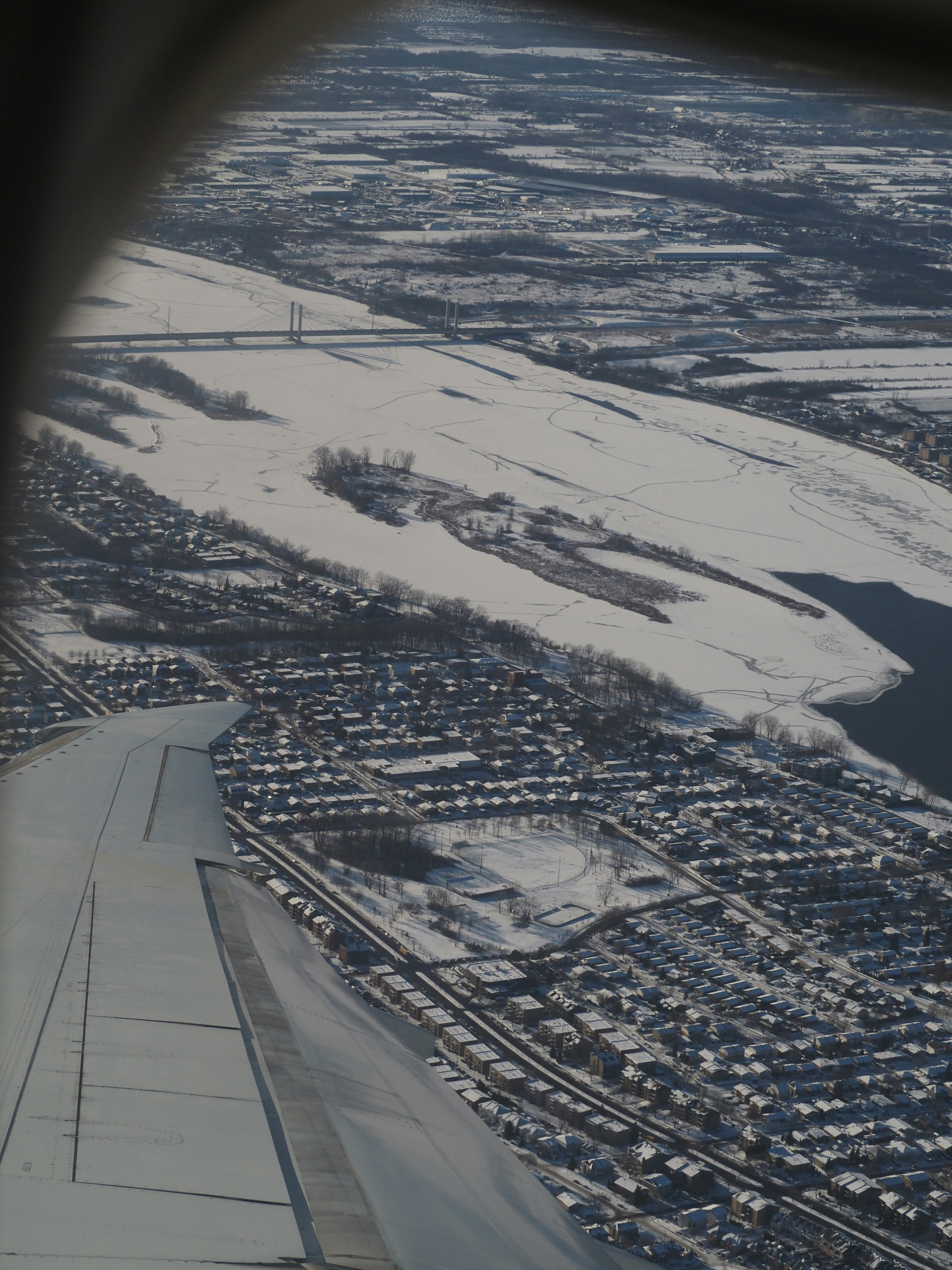 Wing View Over a Snow-Cilled City Below an Elevation of Wings