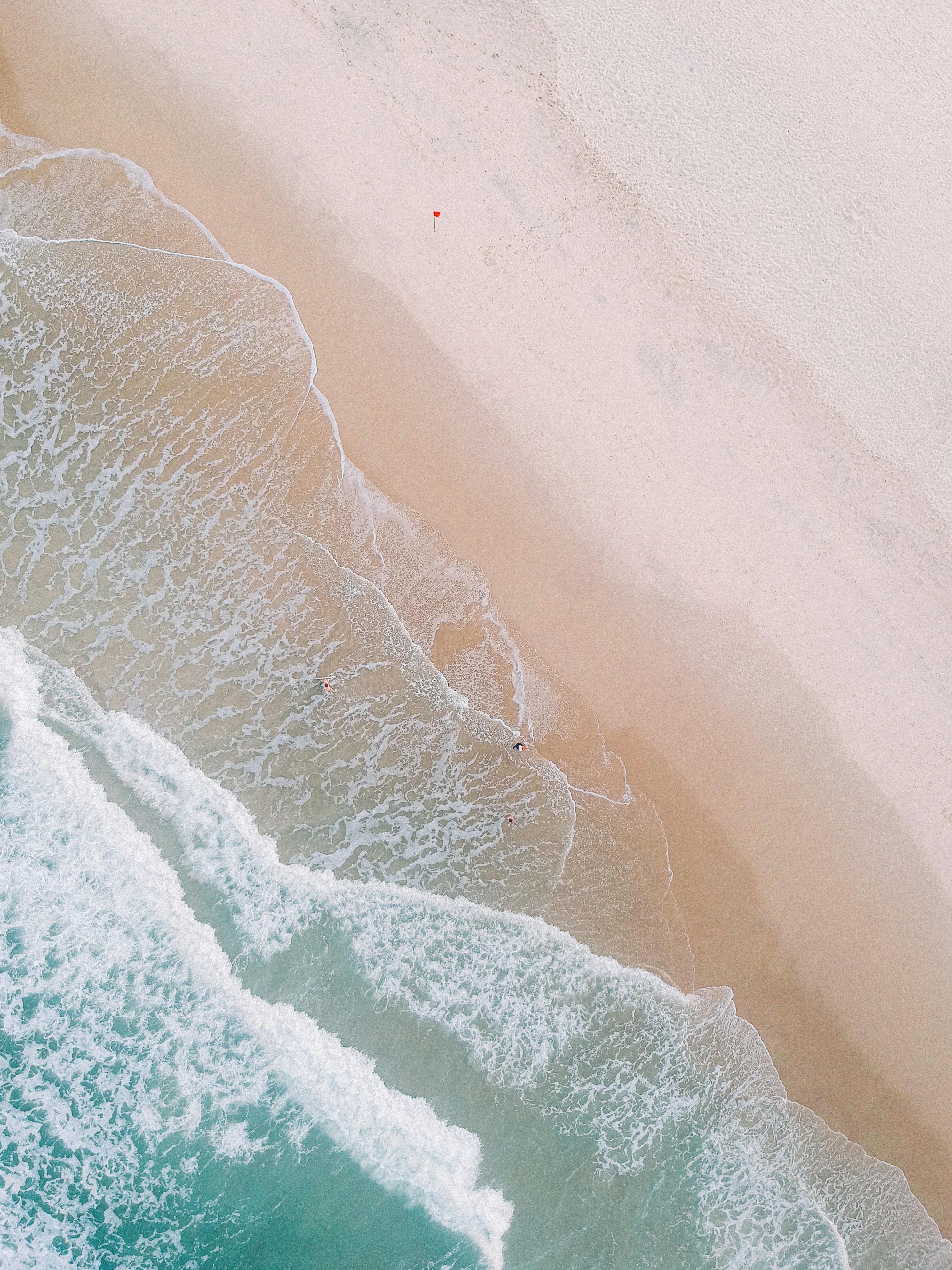 Aerial Quiet: V-shaped shoreline and turquoise waves