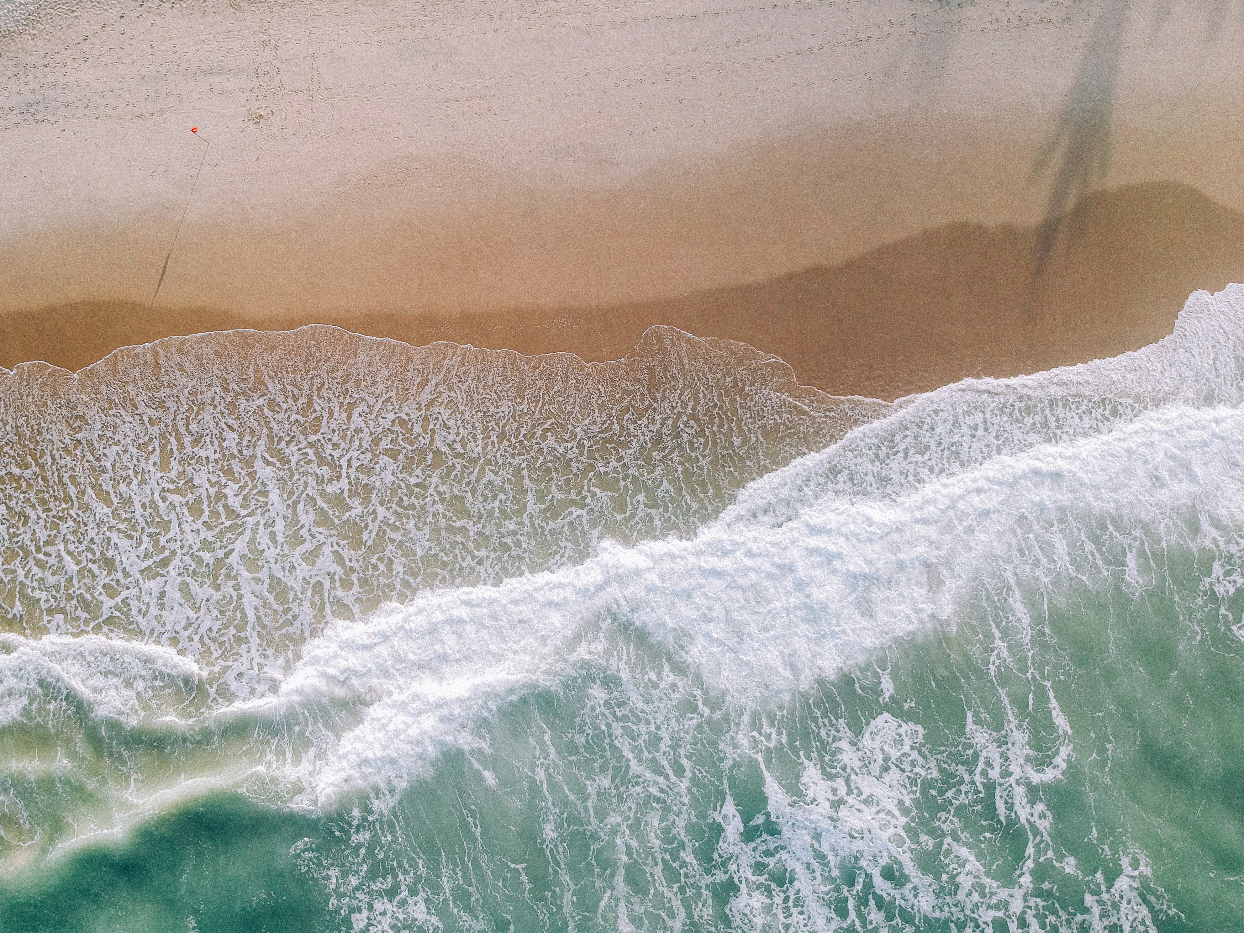 Tidal Veil: Aerial Curtain of Green and Sand