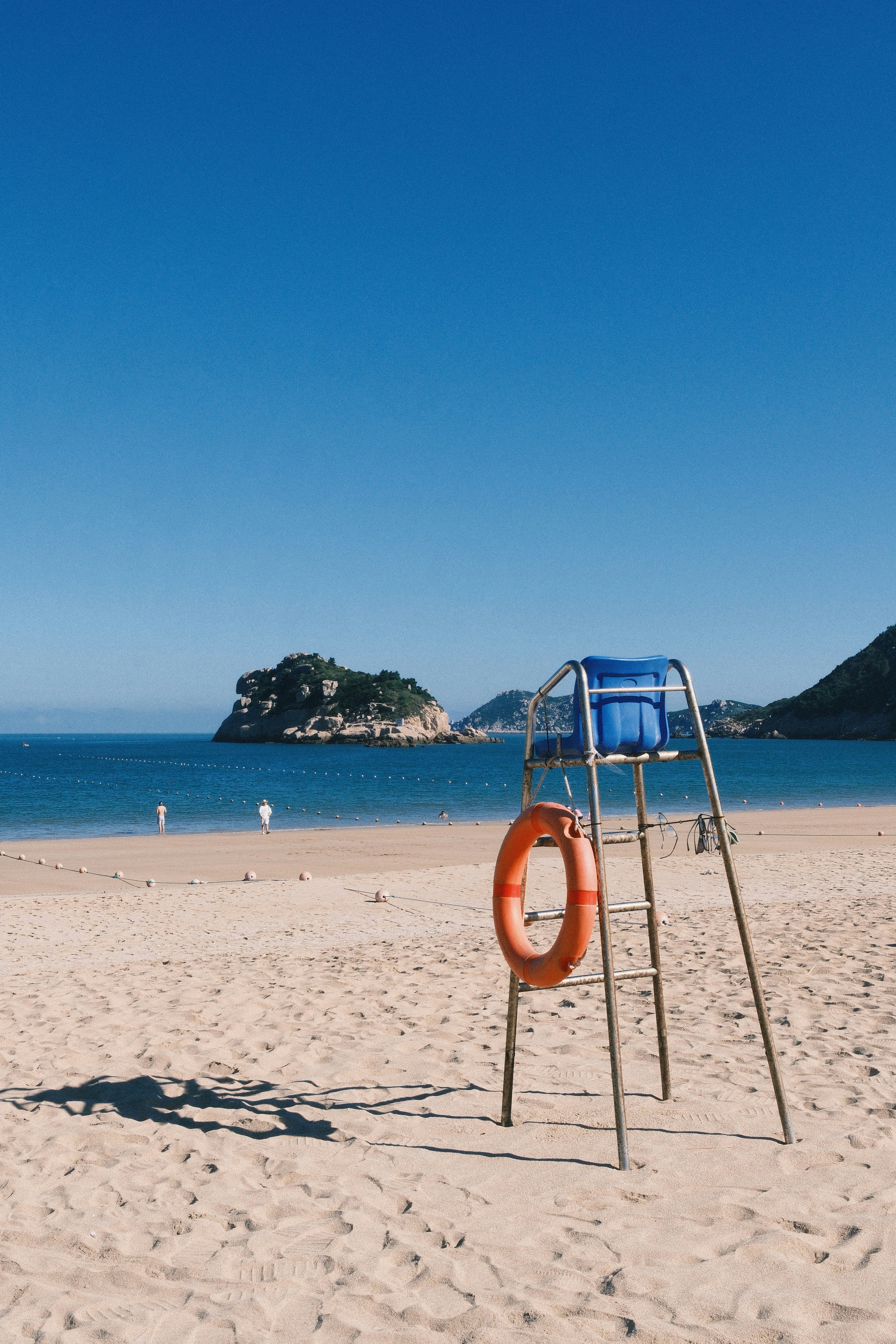 Lifeguard Chair by the Sea Under a Clear Blue Sky