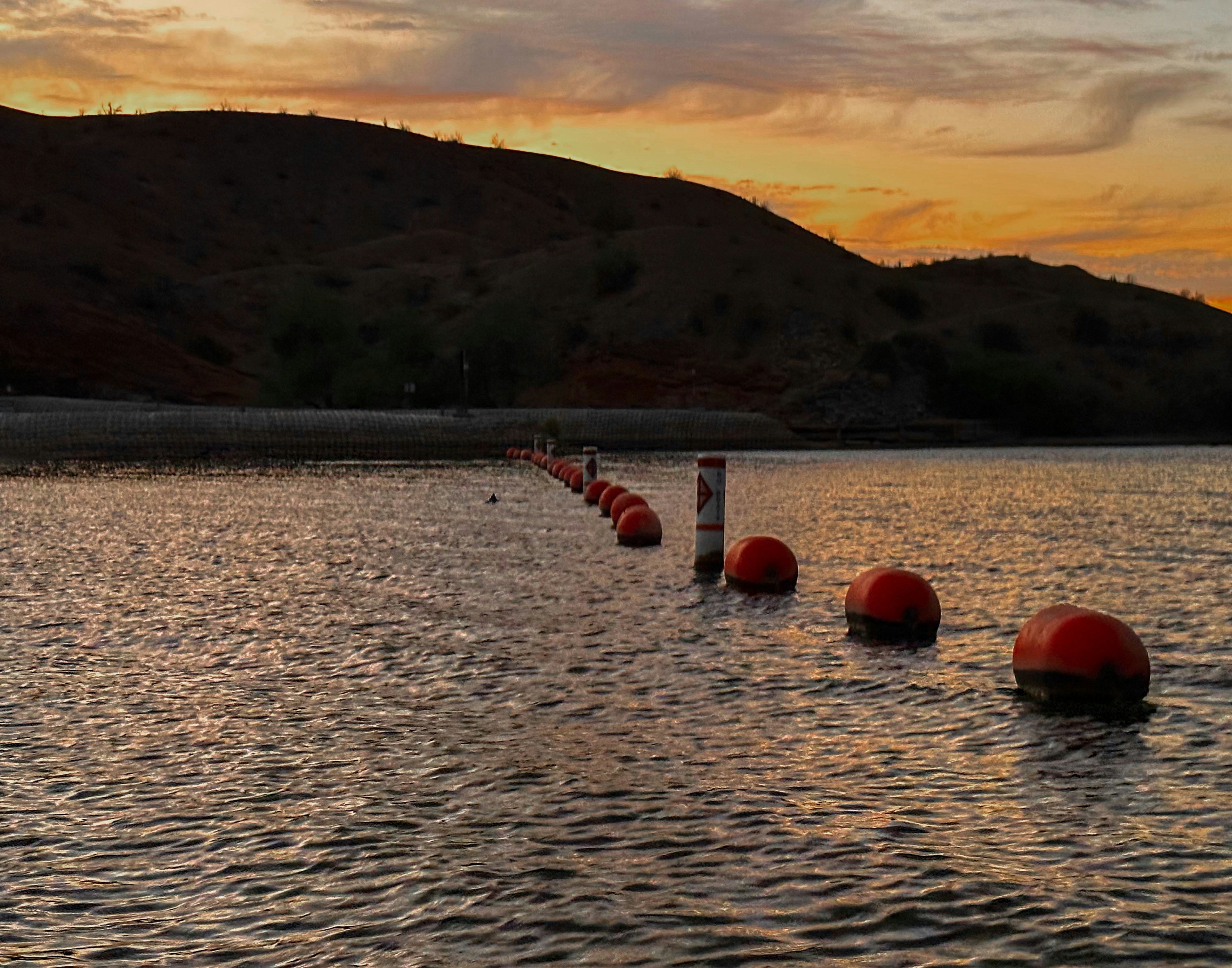 Red Buoys March Across a Quiet Sunset Sea