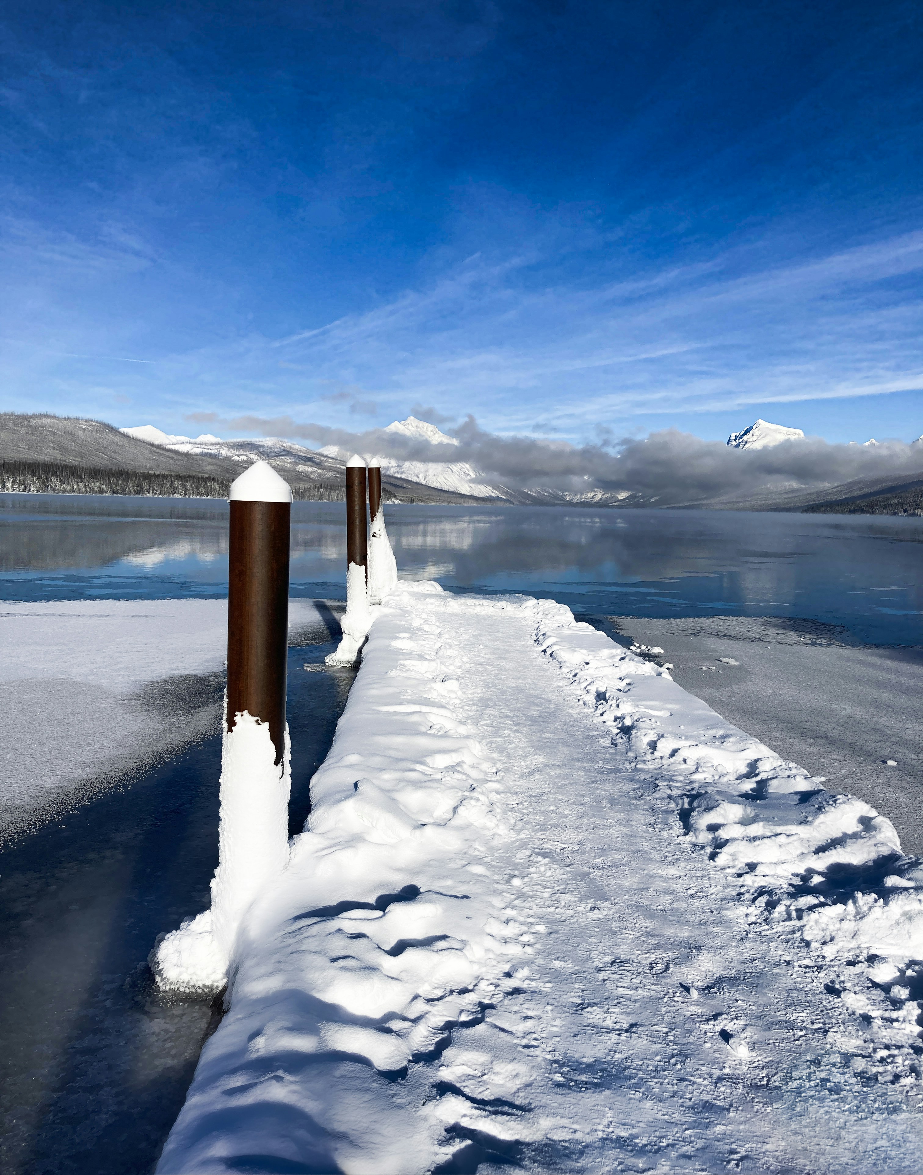 Snowbound Pier Reaching Toward a Tranquil Alpine Horizon
