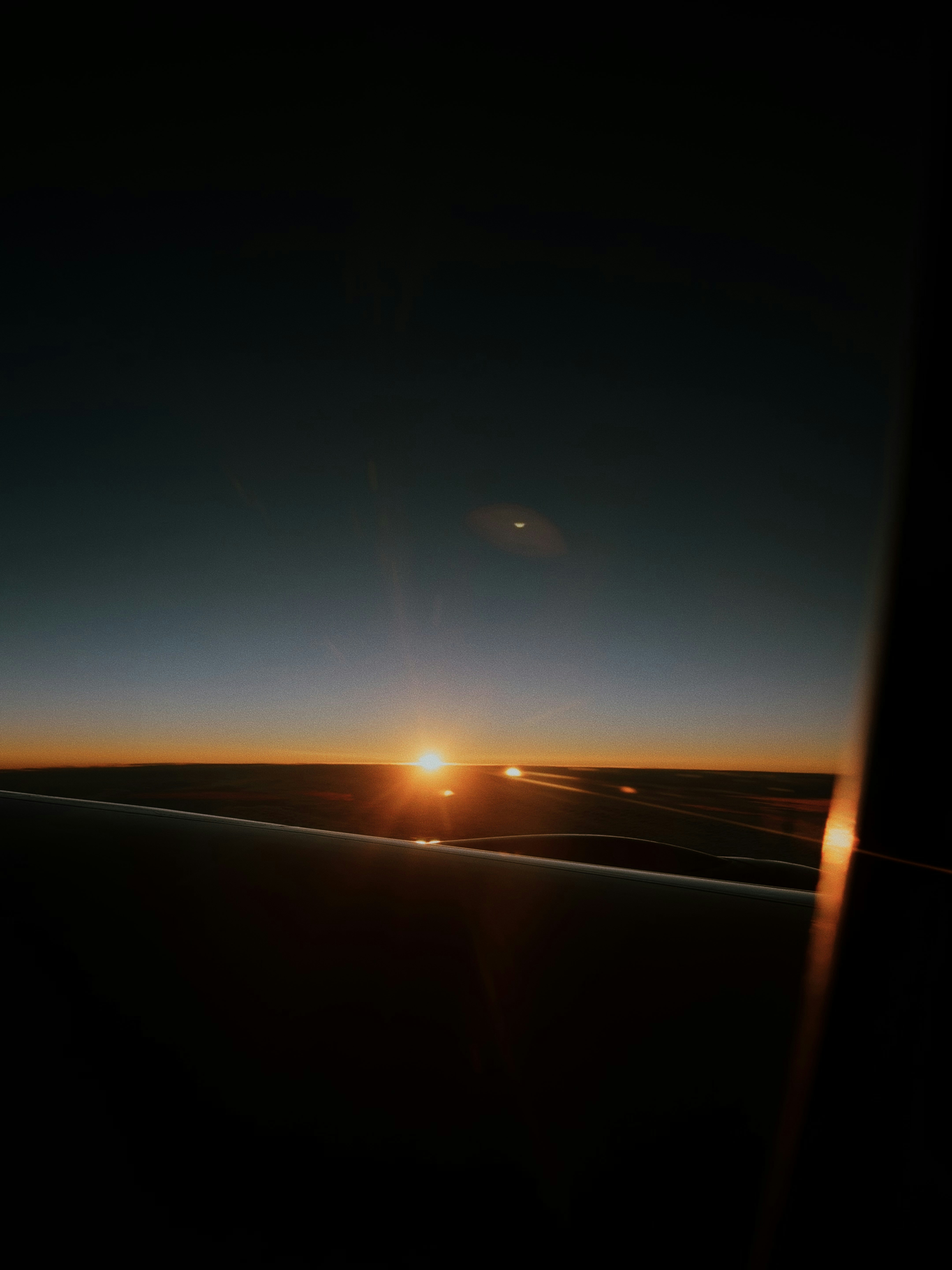 Dawn Horizon from the Wing: Sunrise over the Tarmac