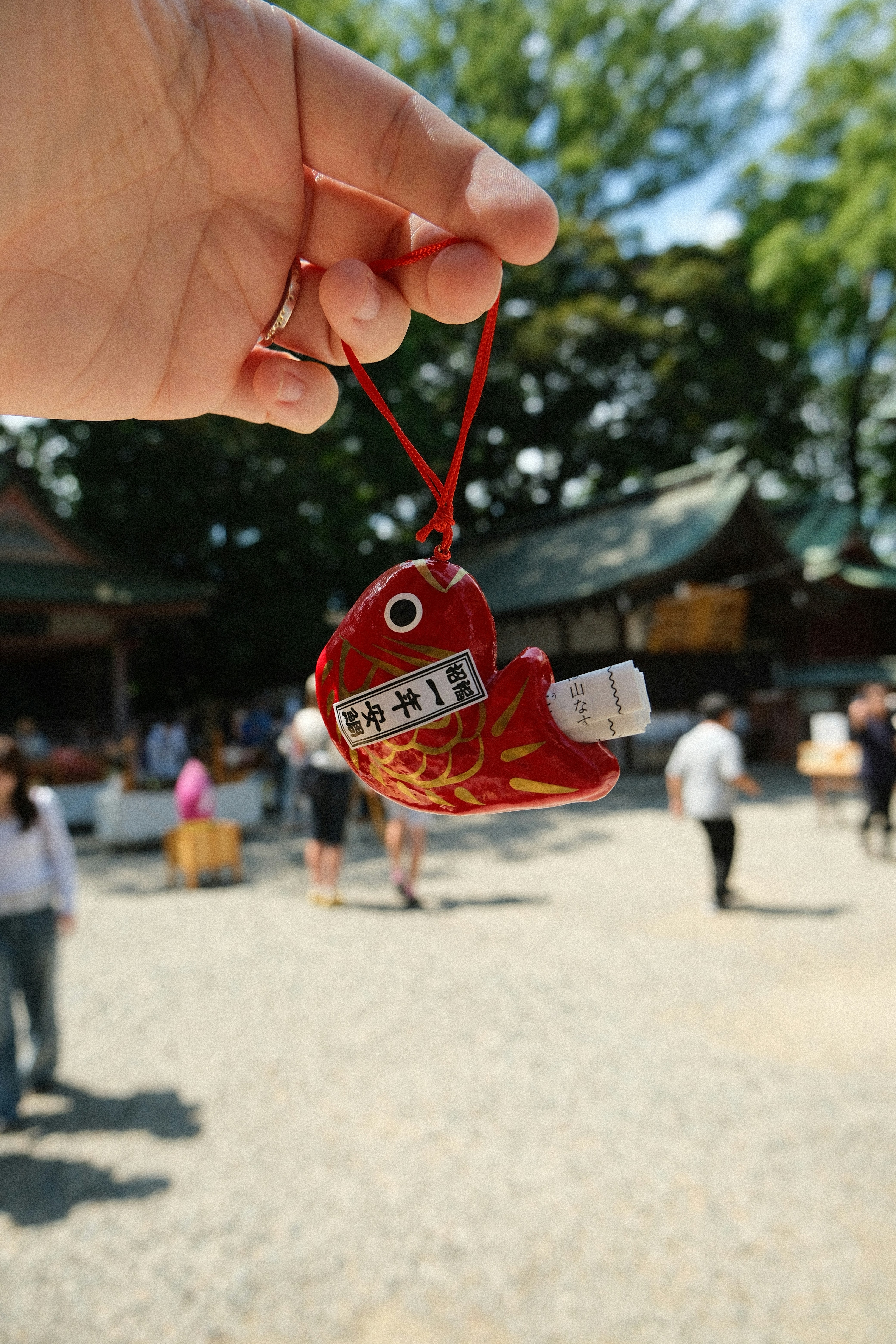 Red Fish Wind Charm: A Shinto Scene in a Shrine Courtyard