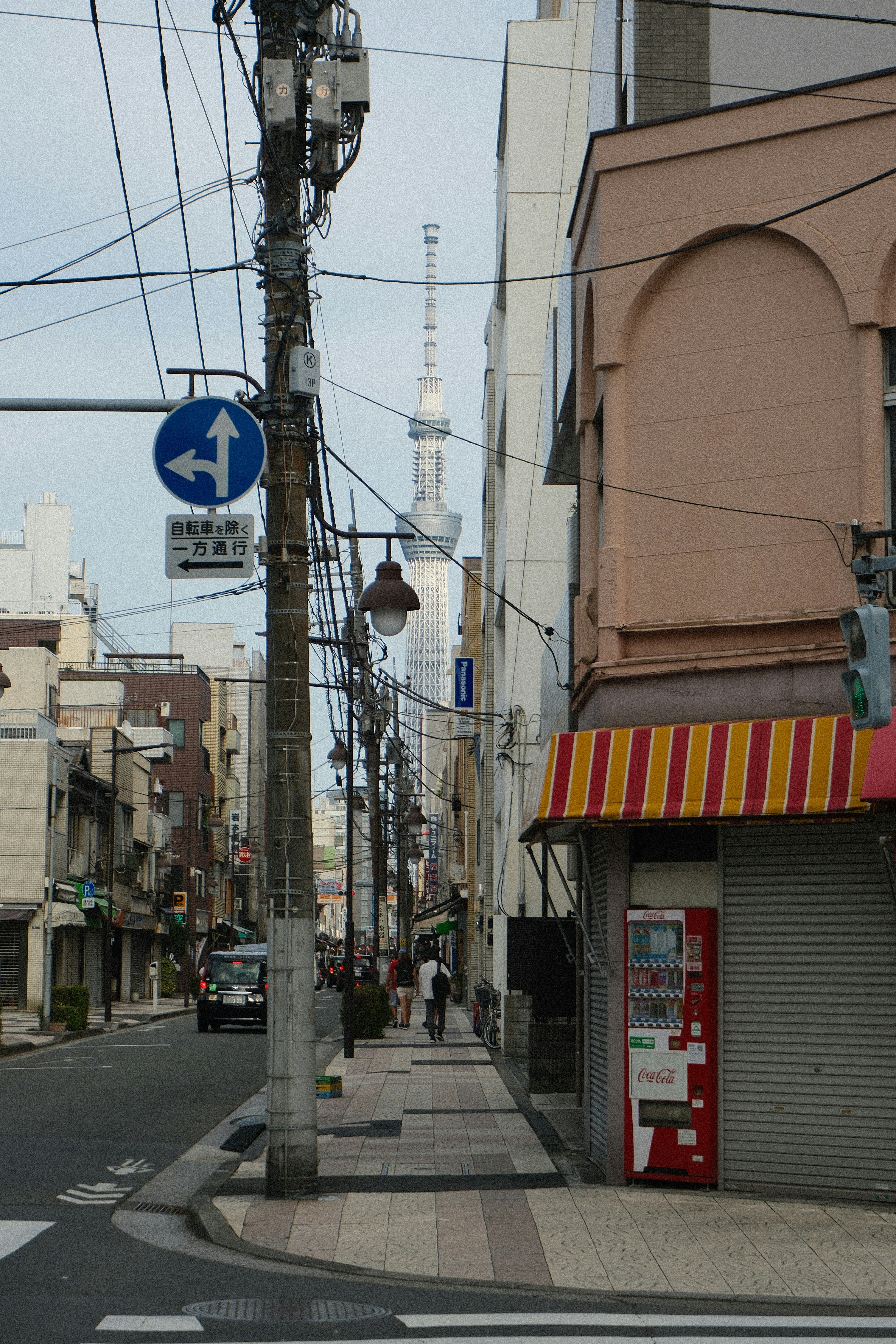 Urban Skyline Gaze: Tokyo Tower Framed by Street Rhythm