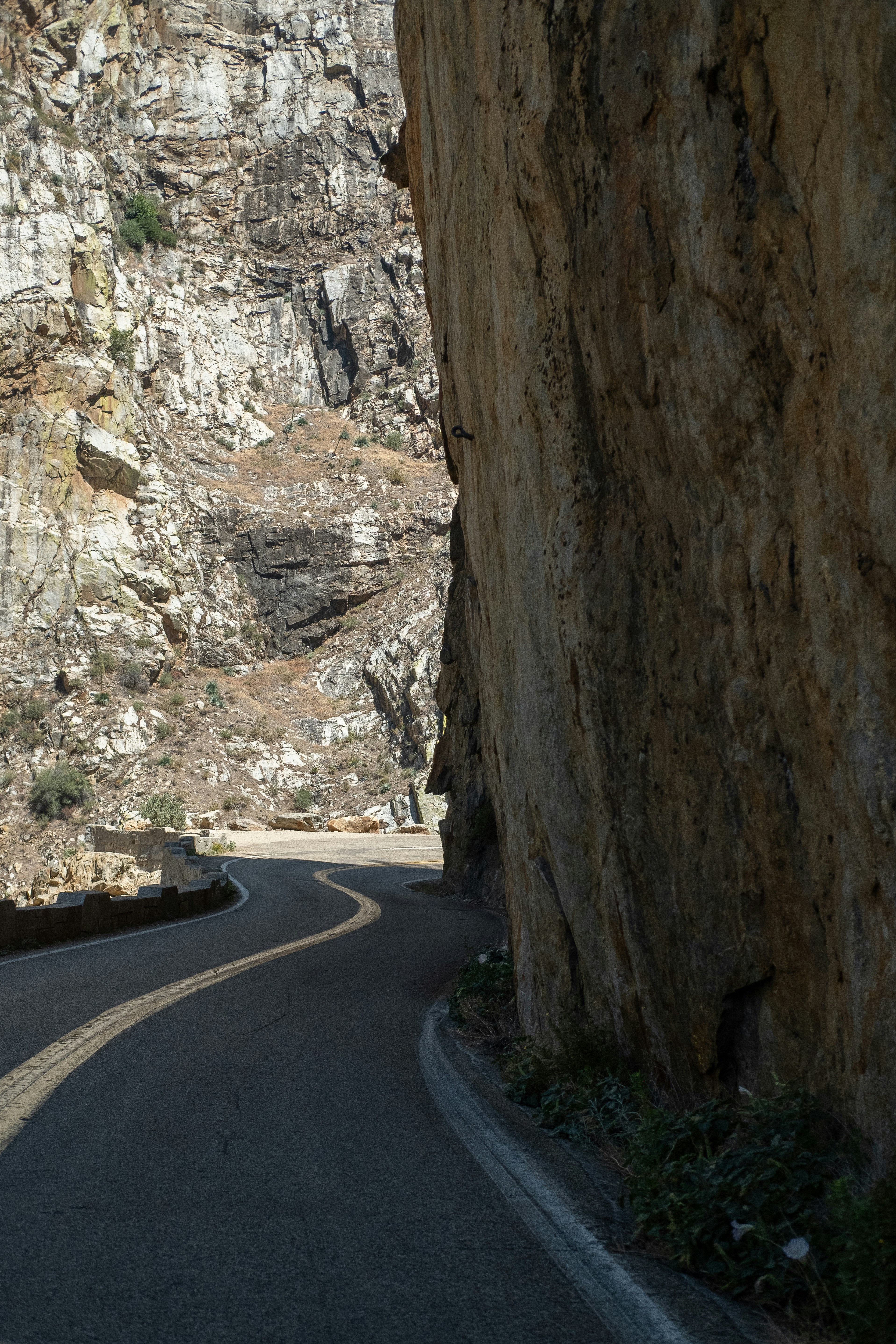 Curve of Quiet Resolve: A Mountain Road Meanders Between Wall and Sky