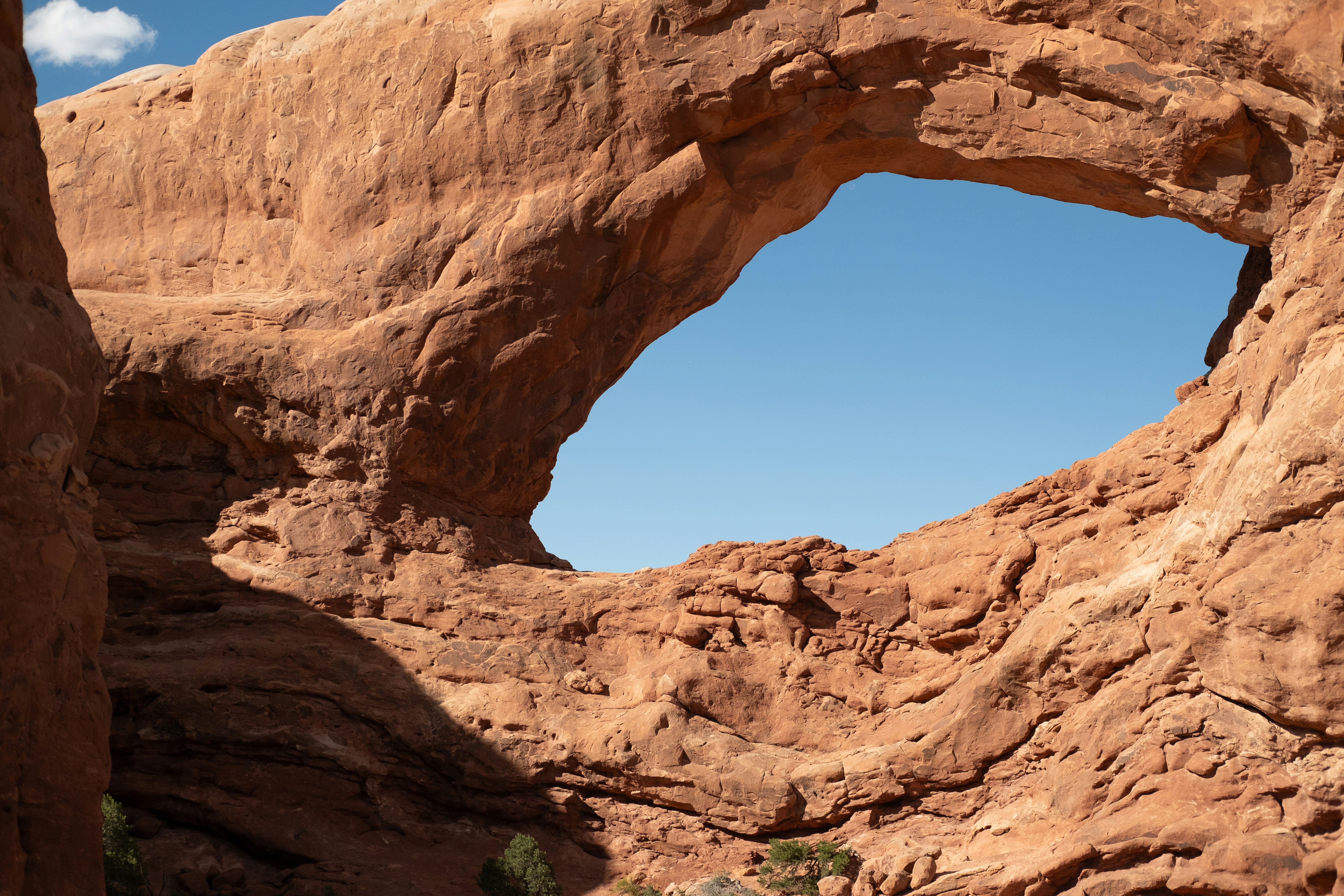 Azure Sky Framed by a Weathered Red Arch