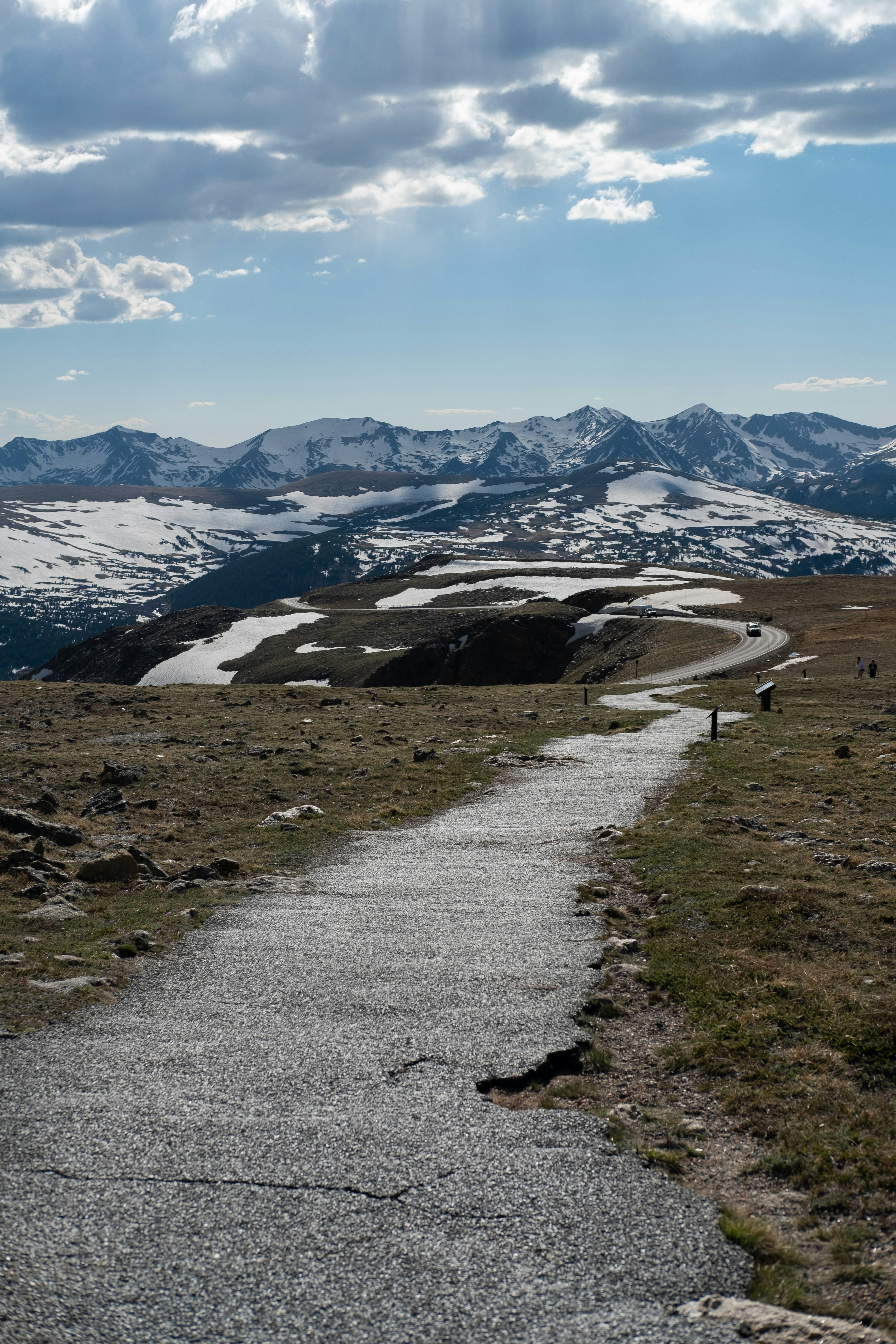 Snow-kissed ascent: a winding path through alpine expanse