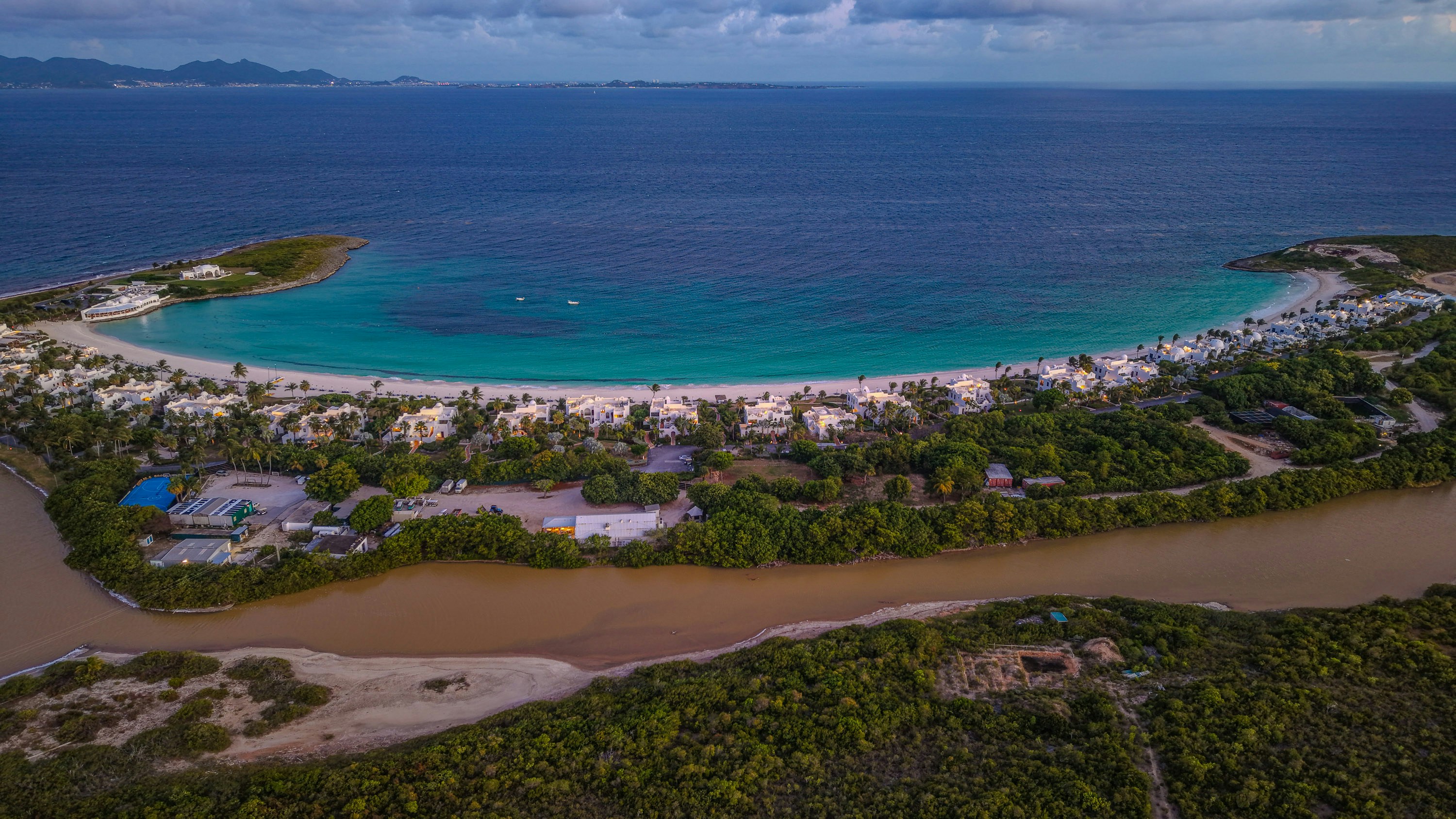 Azure Crescent: Aerial Glimpse of a Coastal Oasis