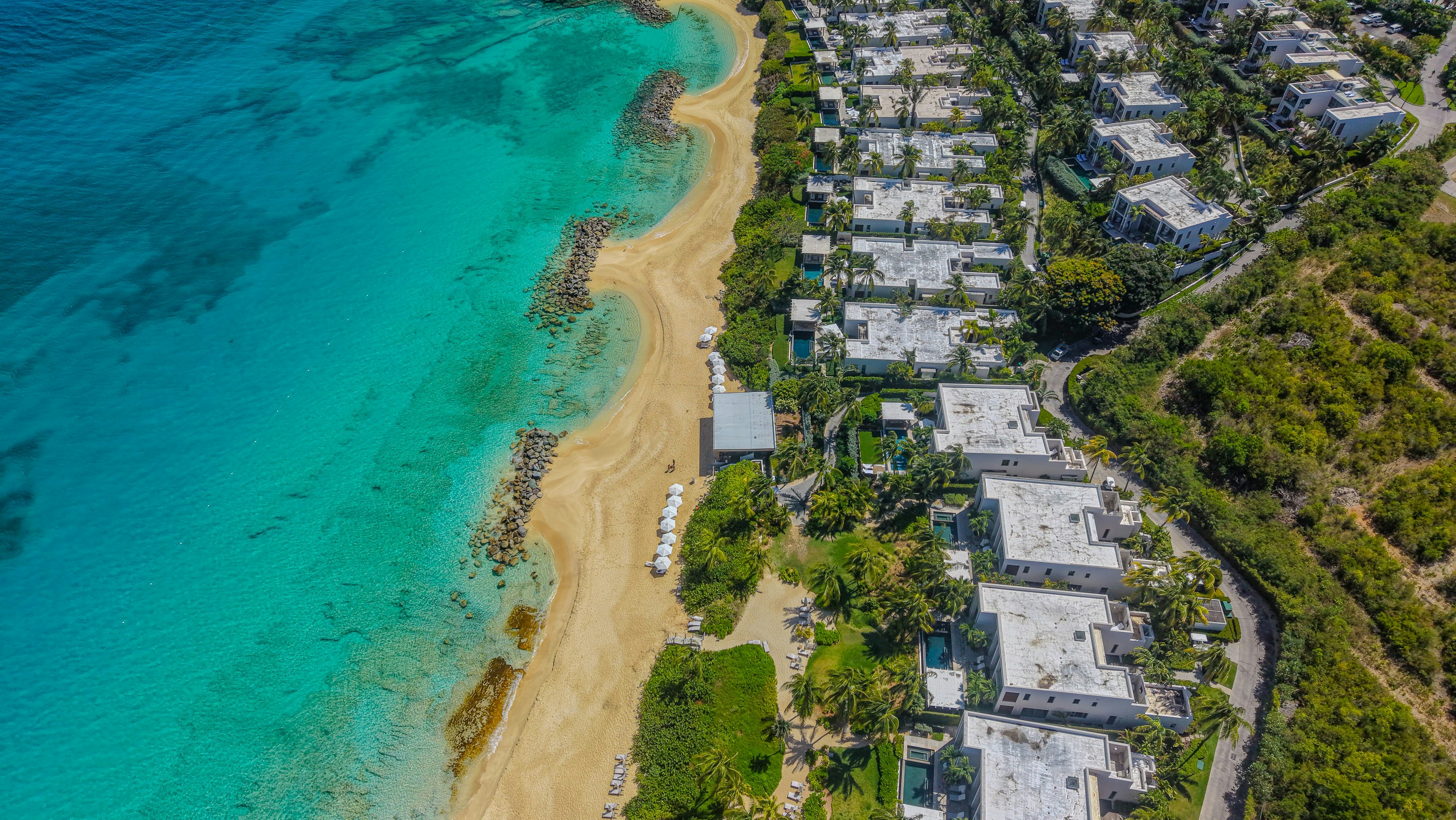 Coastal Resort Rows: Aerial Panorama of Turquoise Sea and Beachfront Town