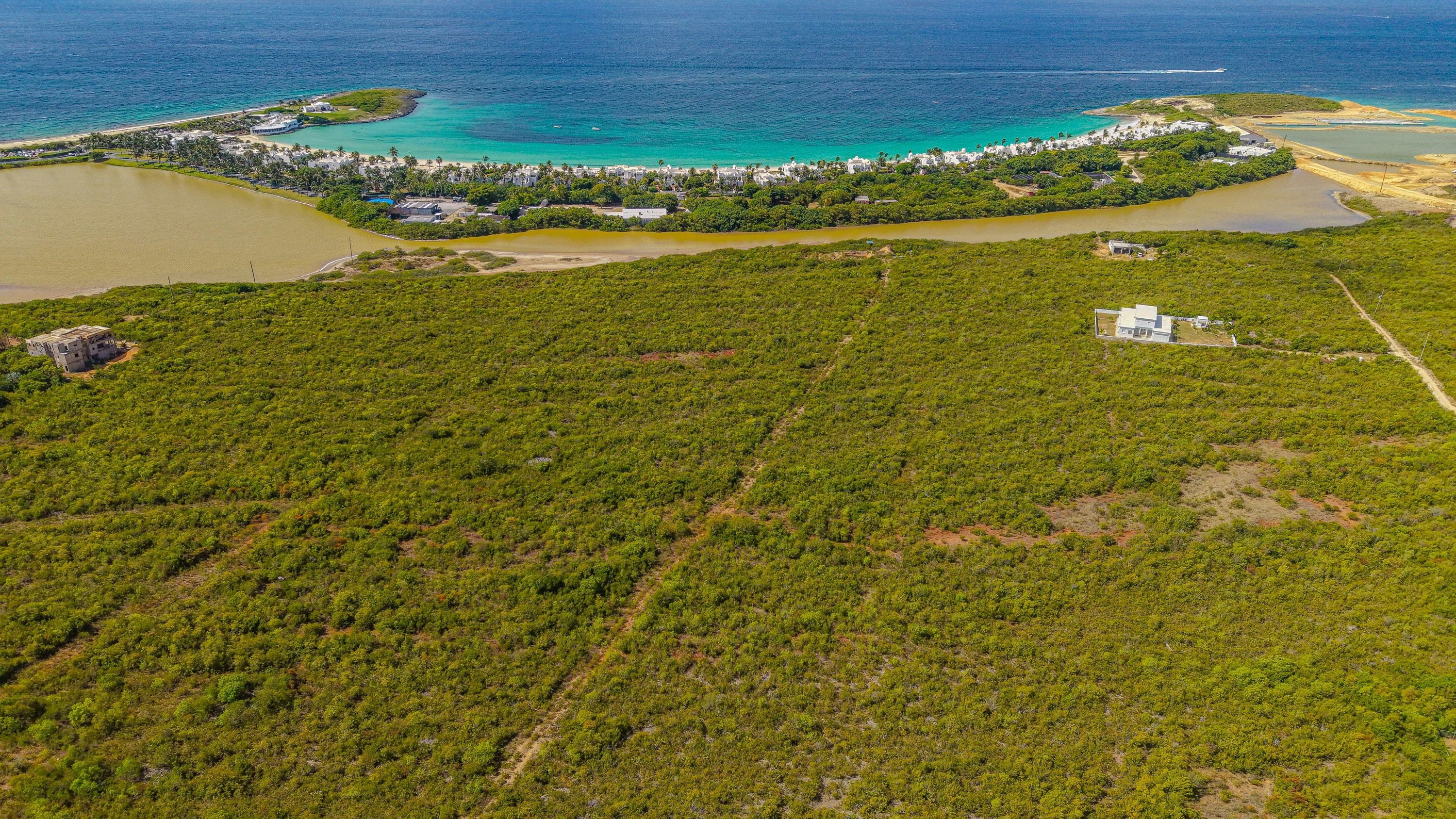 Coastal Green Ridge with Turquoise Lagoon in an Aerial Corridor