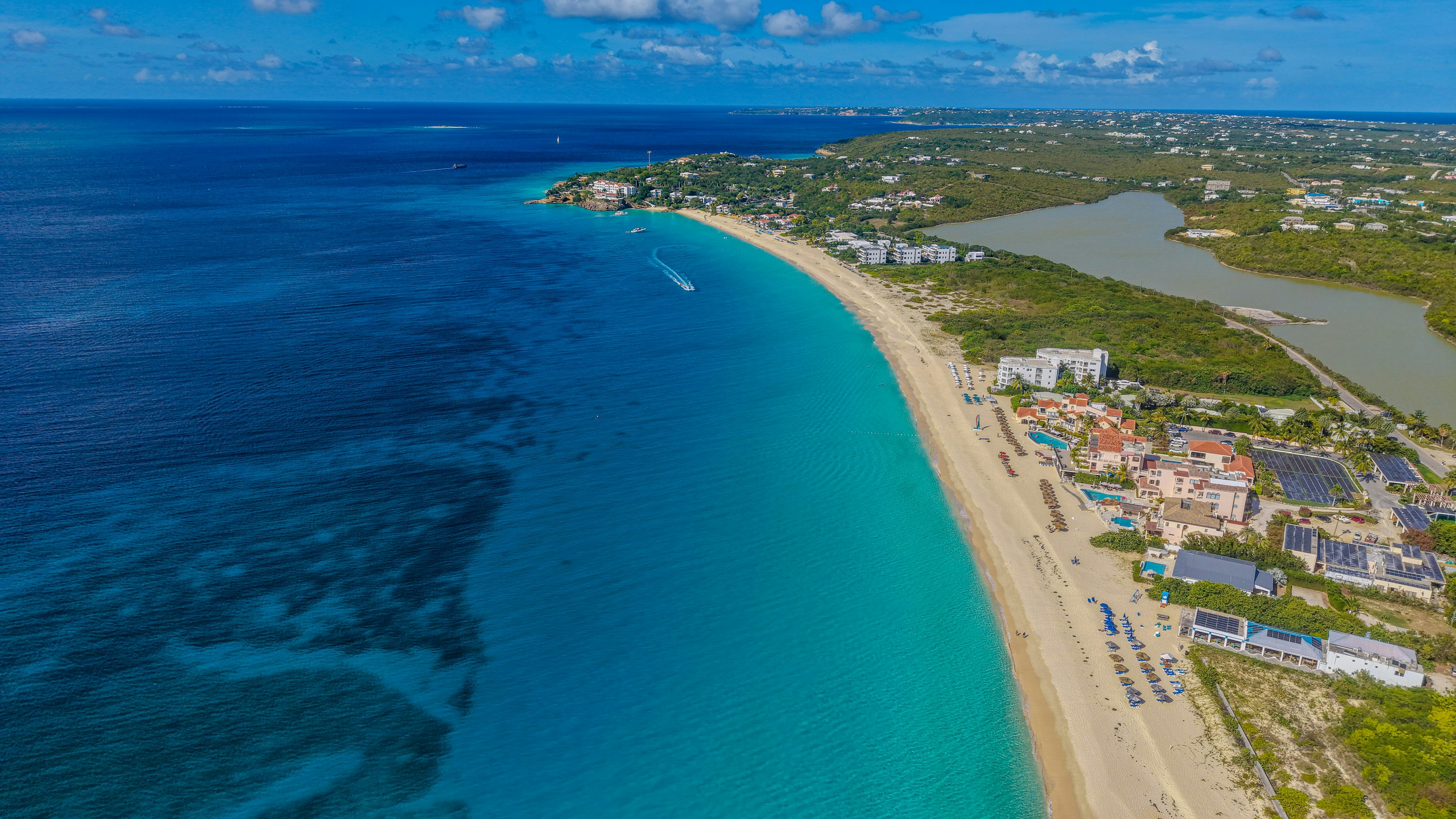 Azure Ribbon: Aerial Coastline with Resort Crescent