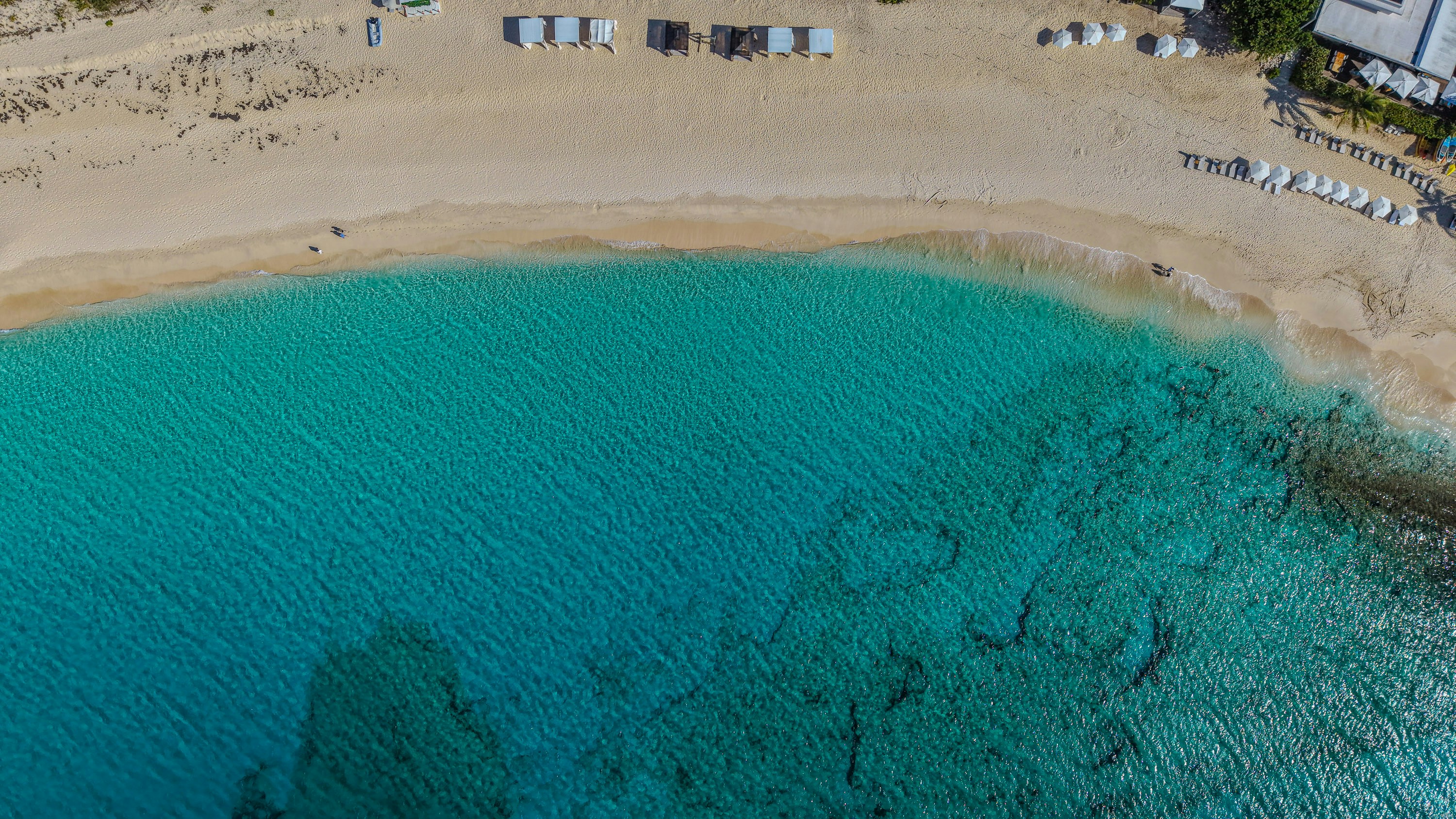 Turquoise Sea Edge: Aerial Spotlight on Beachfront Dunes