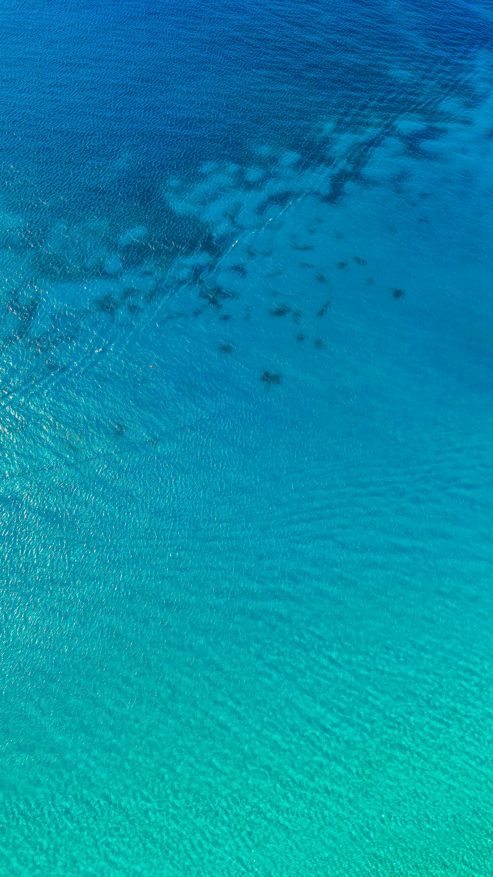Tongue of Color: A Turquoise Sea Meeting Sunlit Sand