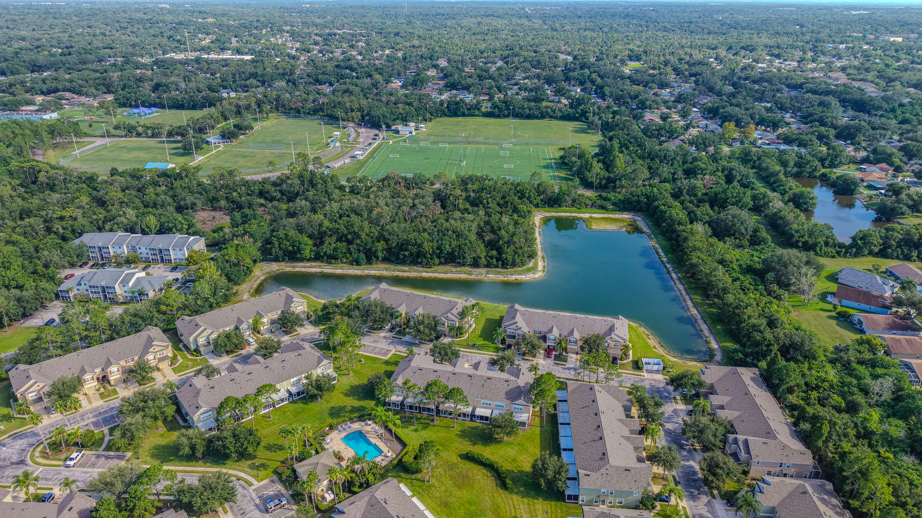 Aerial Retreat: Campus-style Housing Framed by Verdant Fields and Water