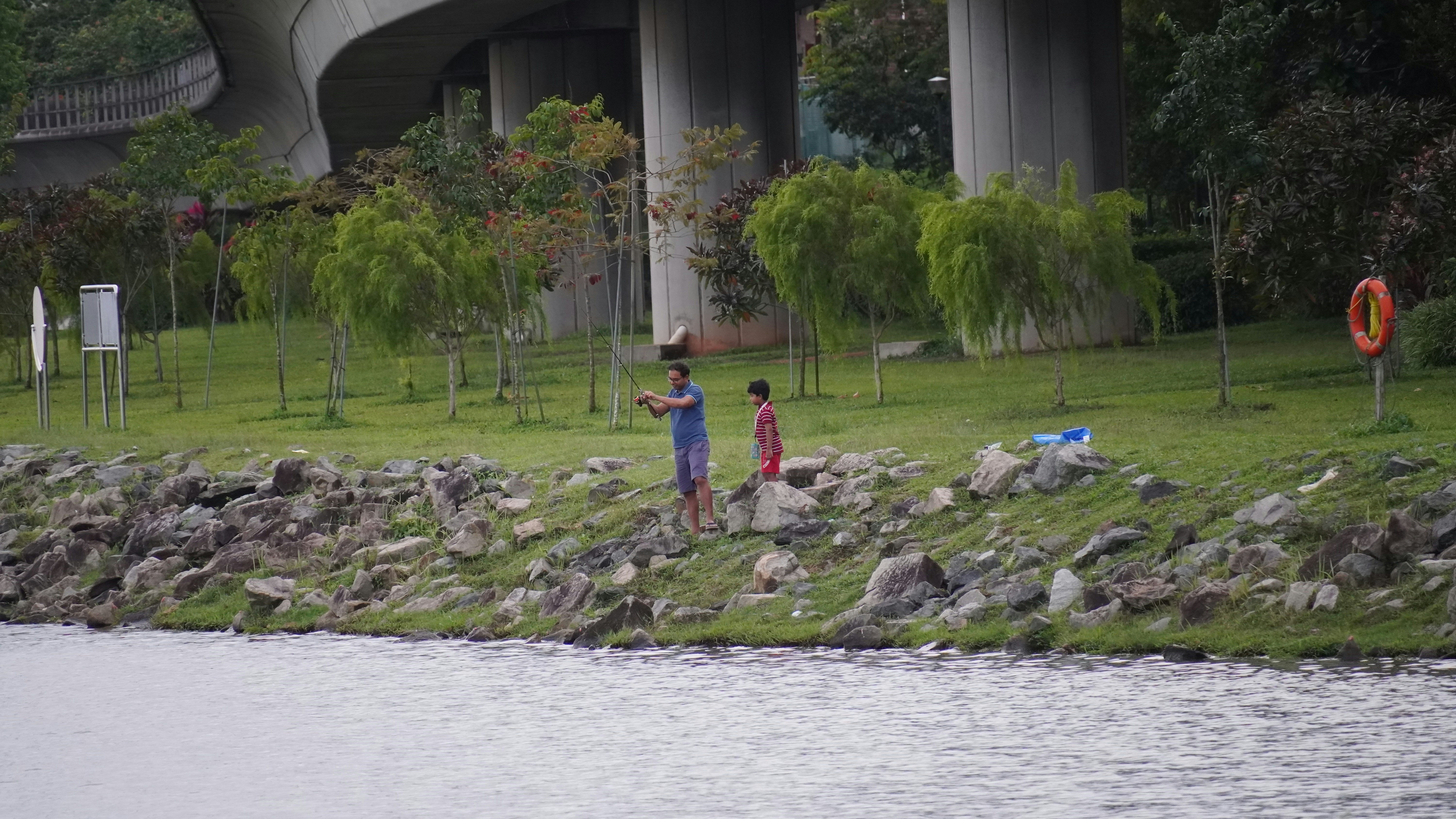 Riverside Waltz: Two Figures by the Water’s Edge