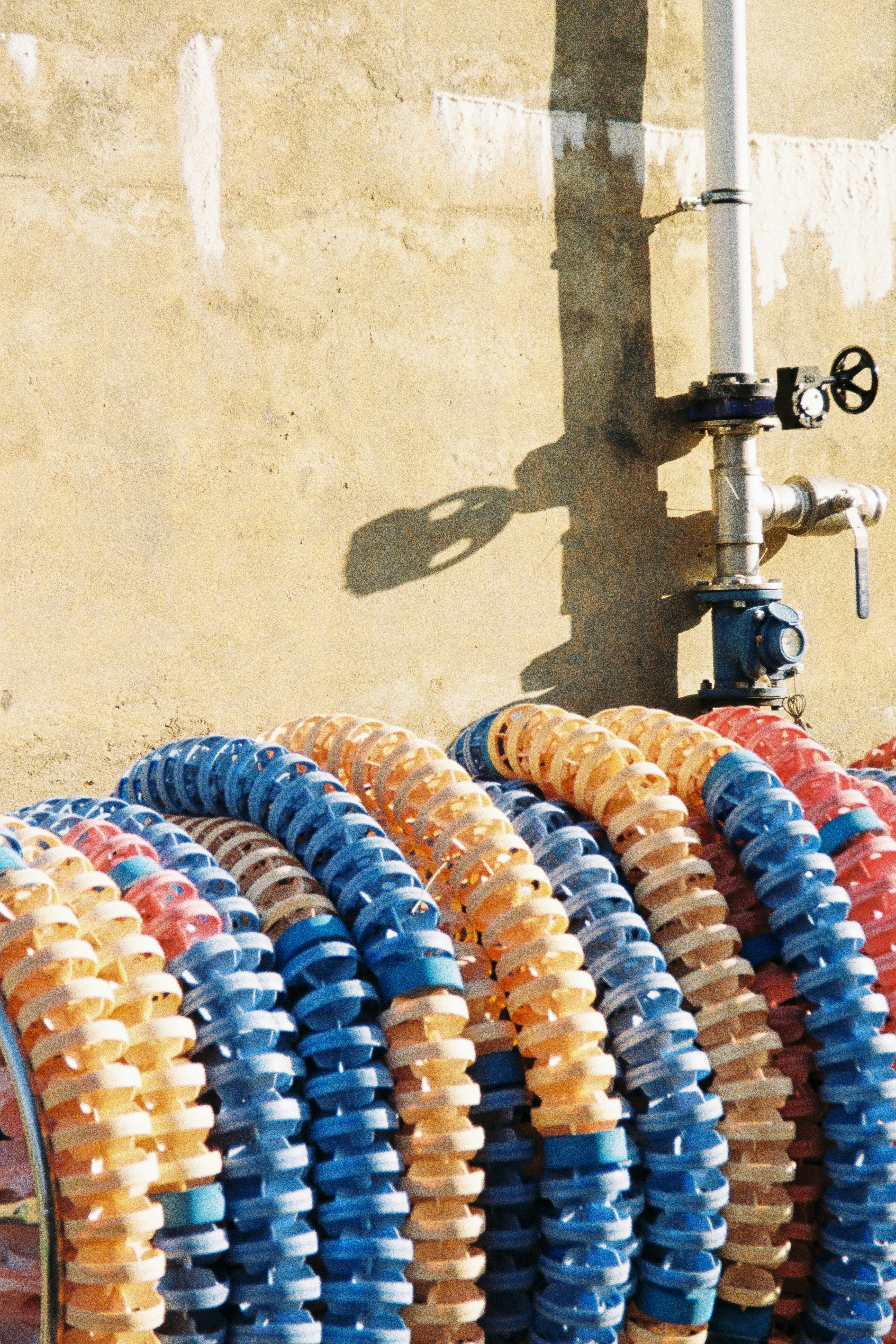 Coiled Copper-and-Paint: A Stream of Color Around a Utility Valve