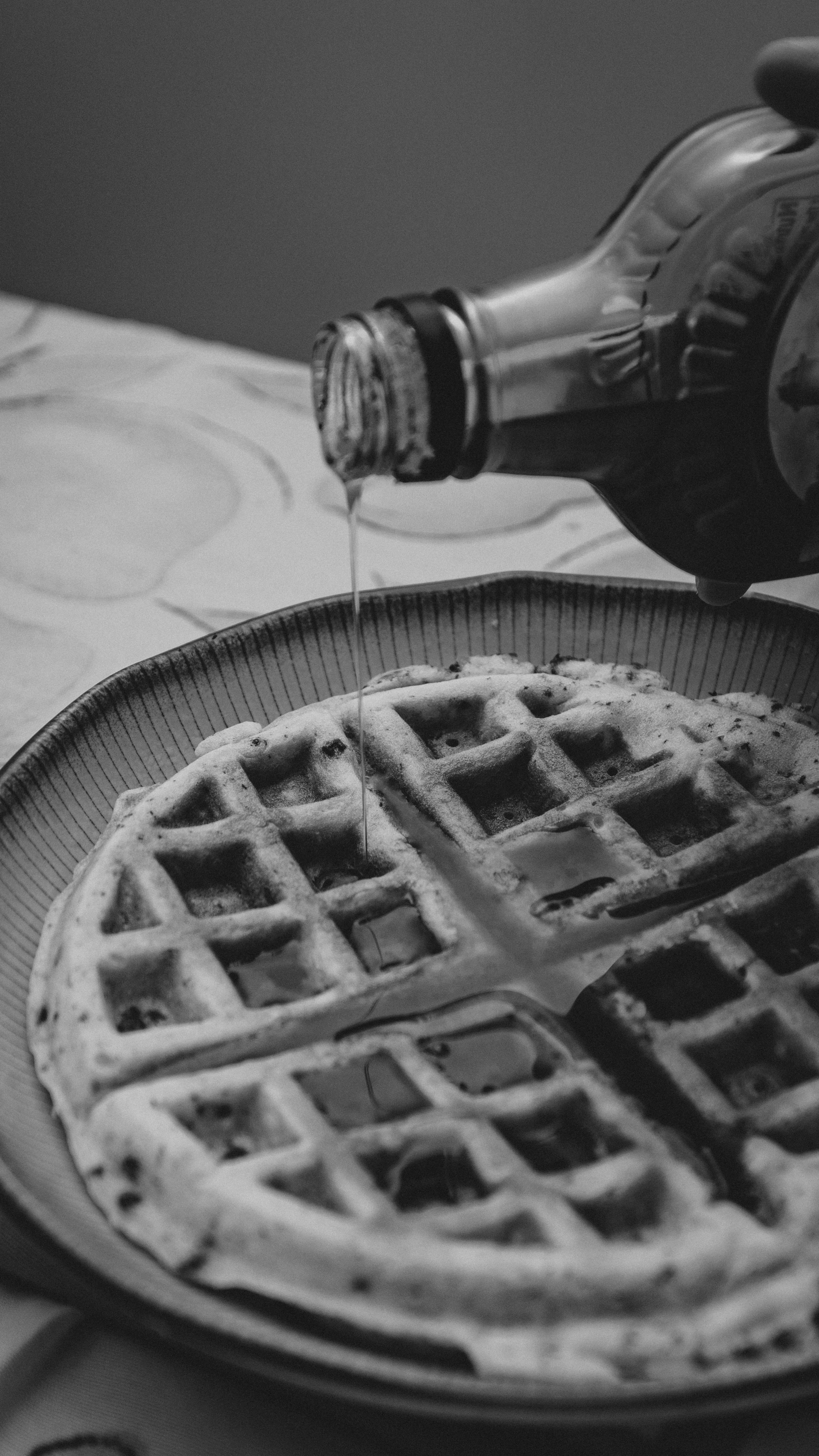 Liquid Gold on Waffles: Syrup Trickle over Griddled Craters