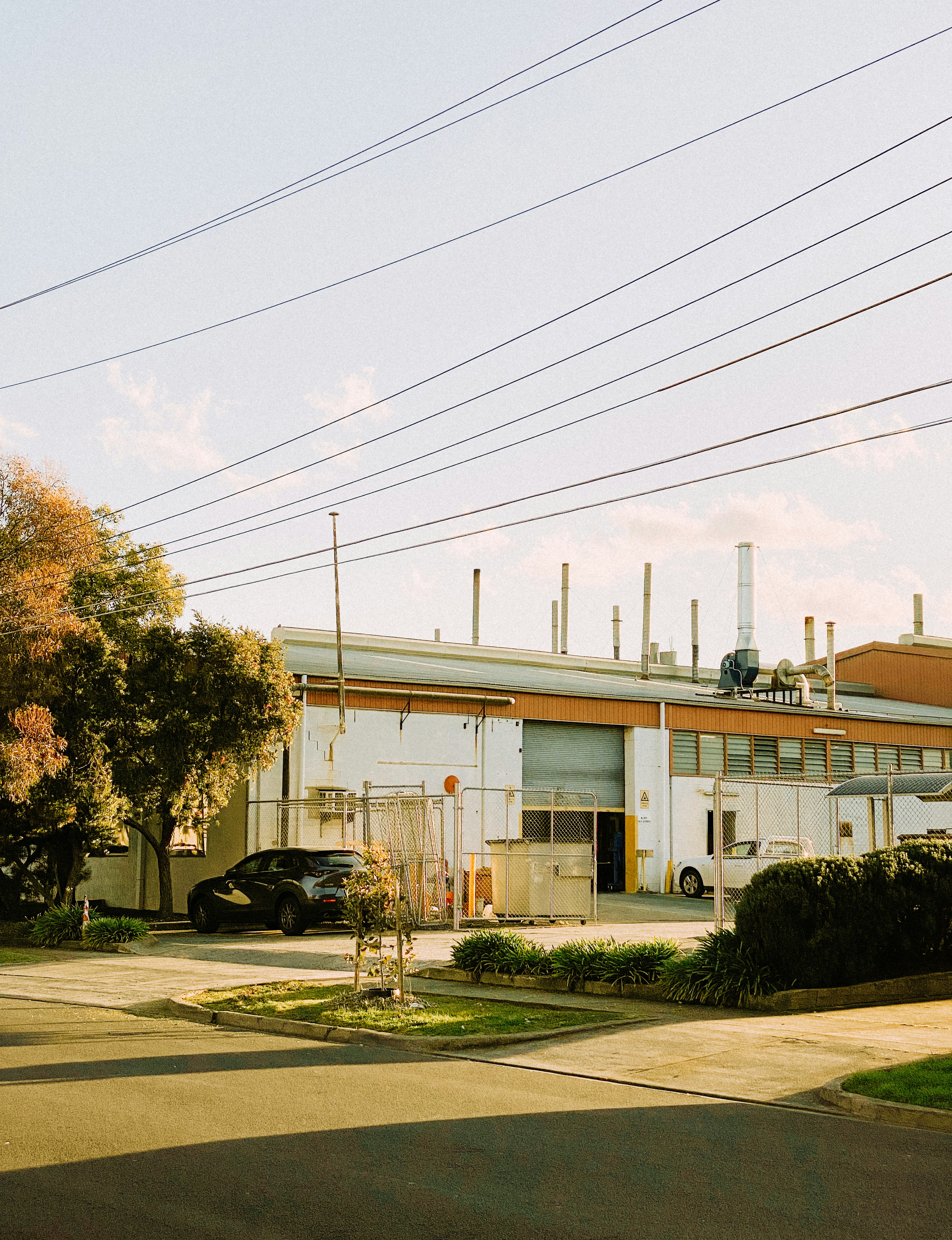 Industrial courtyard under a web of power lines at dawn