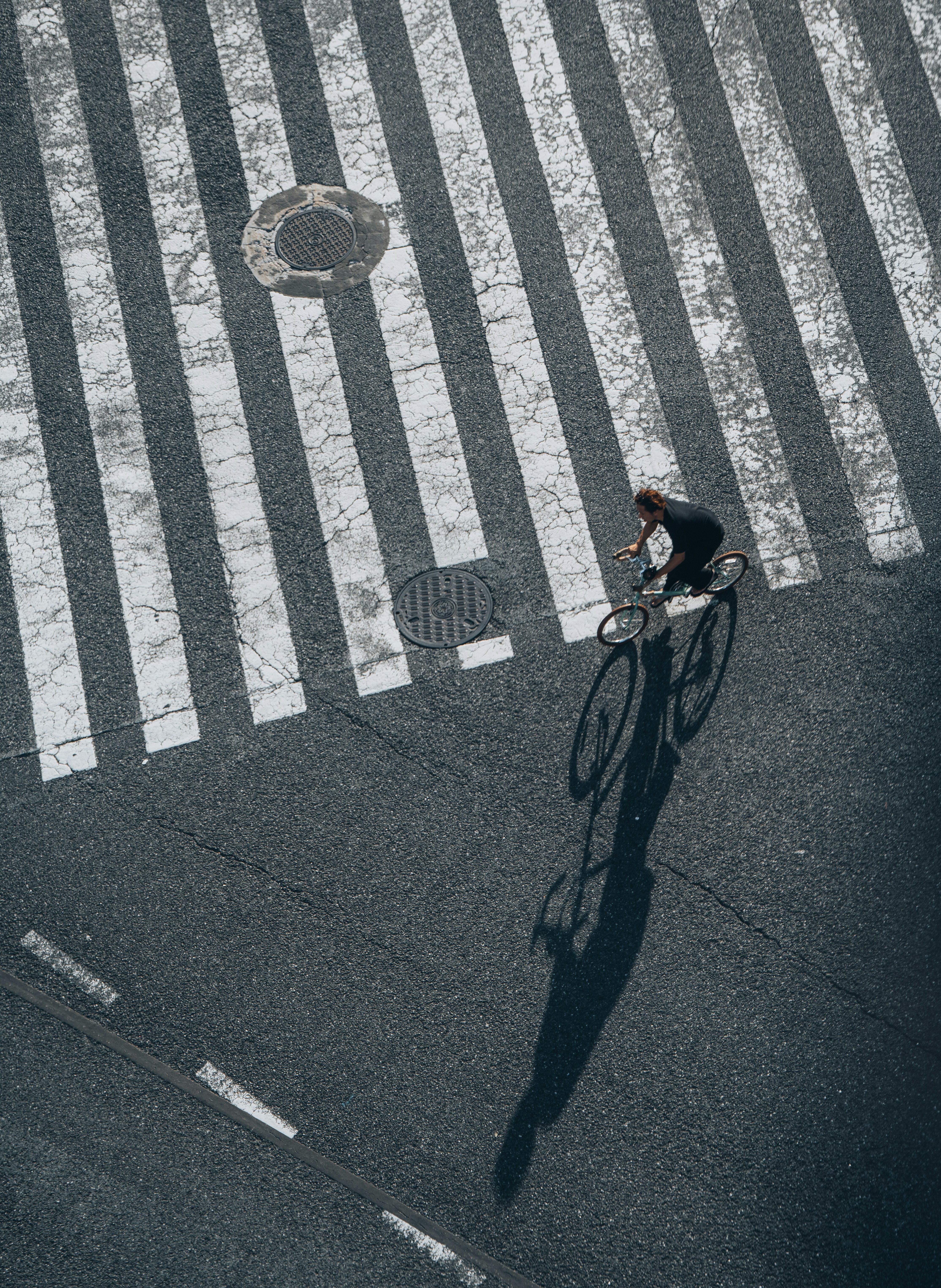Pedestrian in the Crosswalk Cast by a Long Shadow