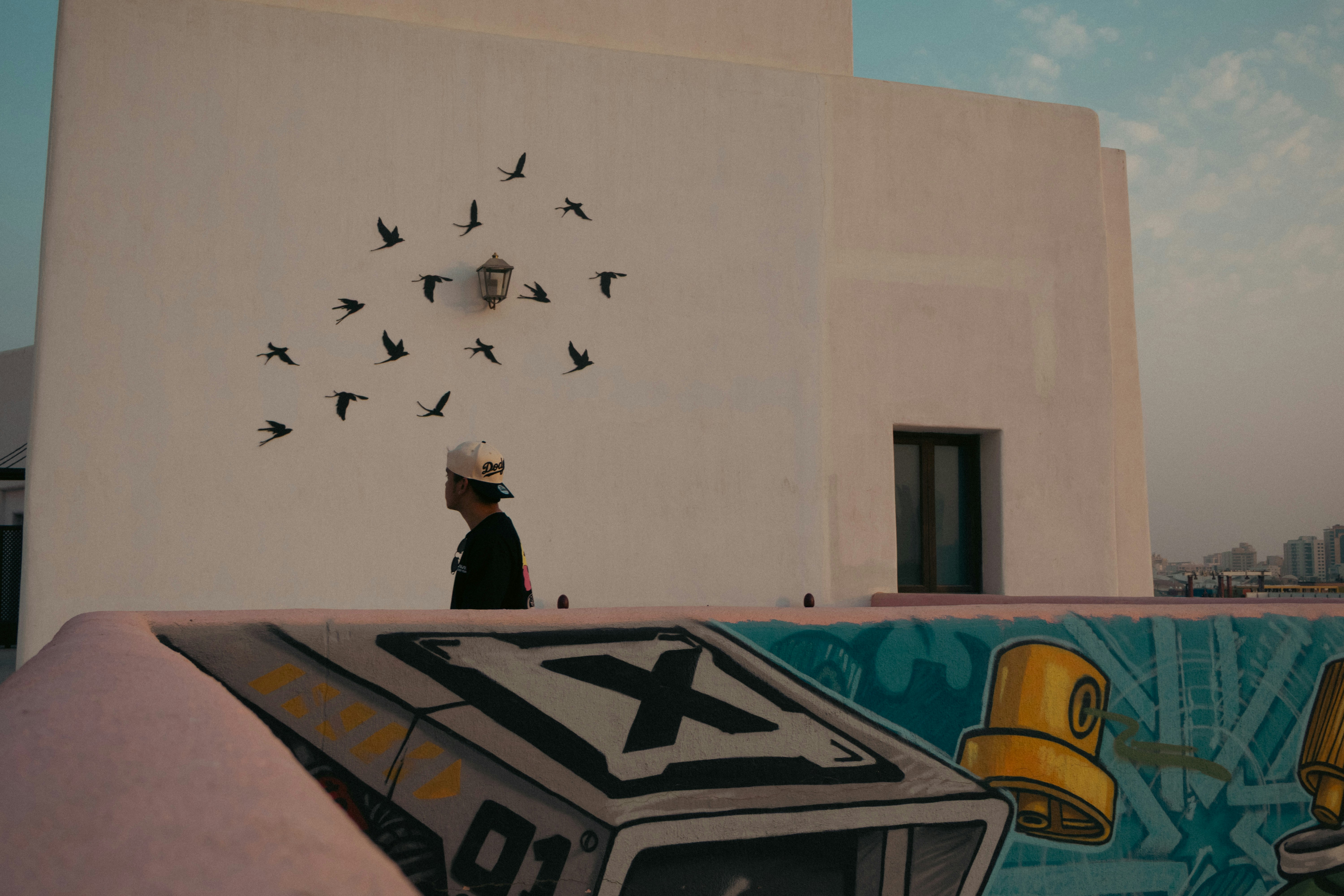 Rooftop Rider and Flock of Drones of Birds