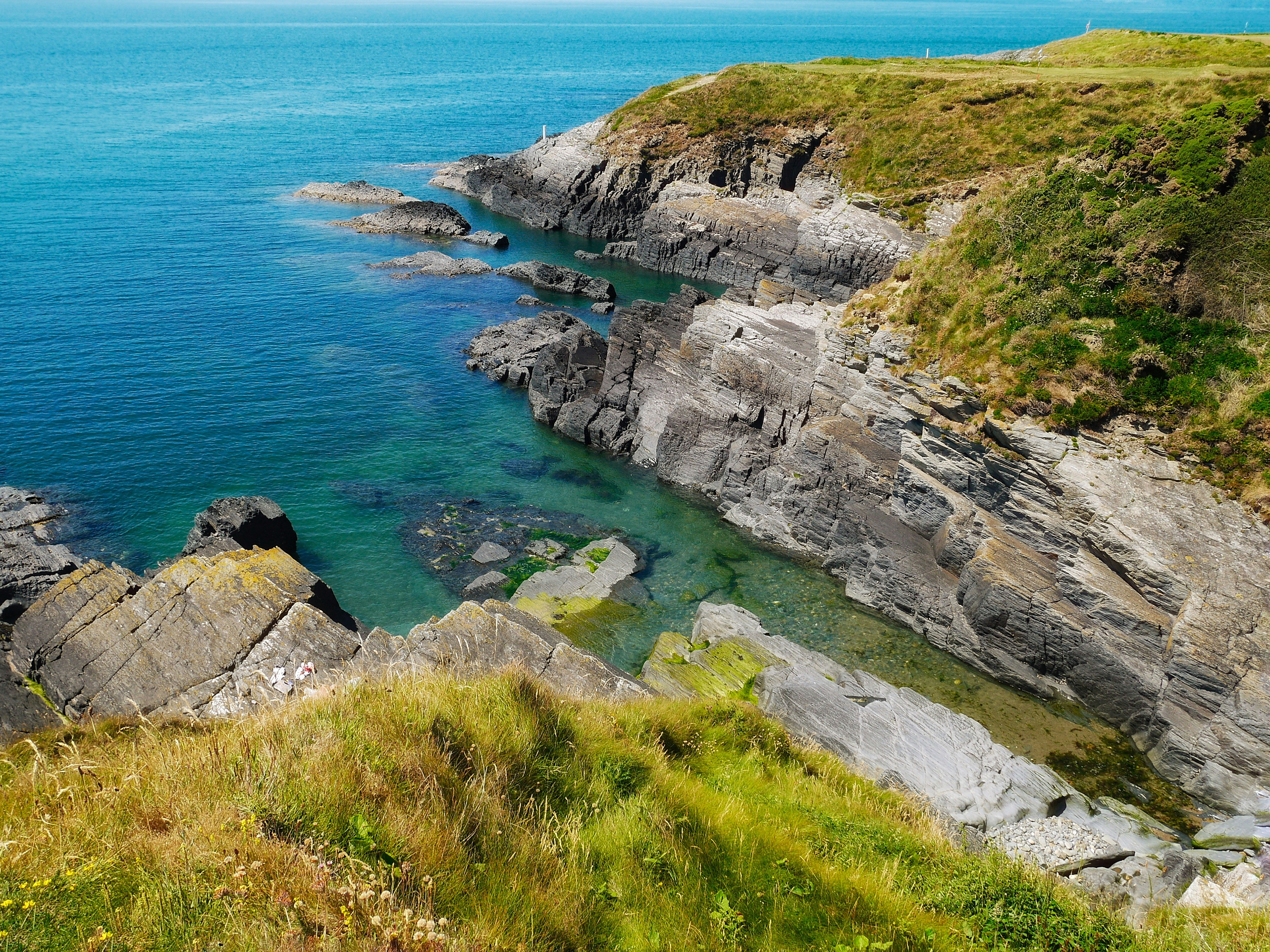Cliffside Harmony: Terraced Rocks Meeting Turquoise Seas