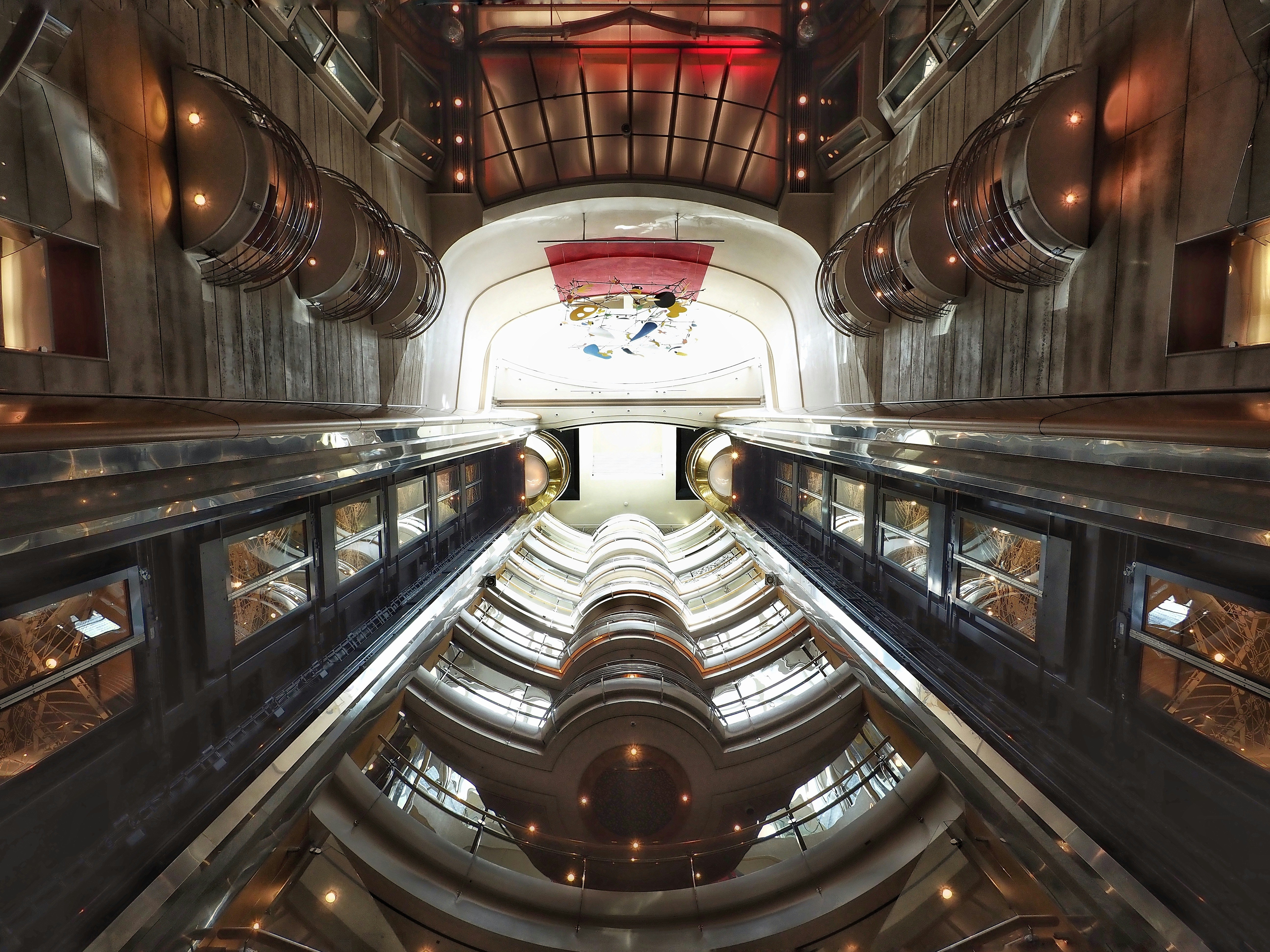 Aerial Atrium: Symmetrical Descent into a Glass-Ck Elevator Core