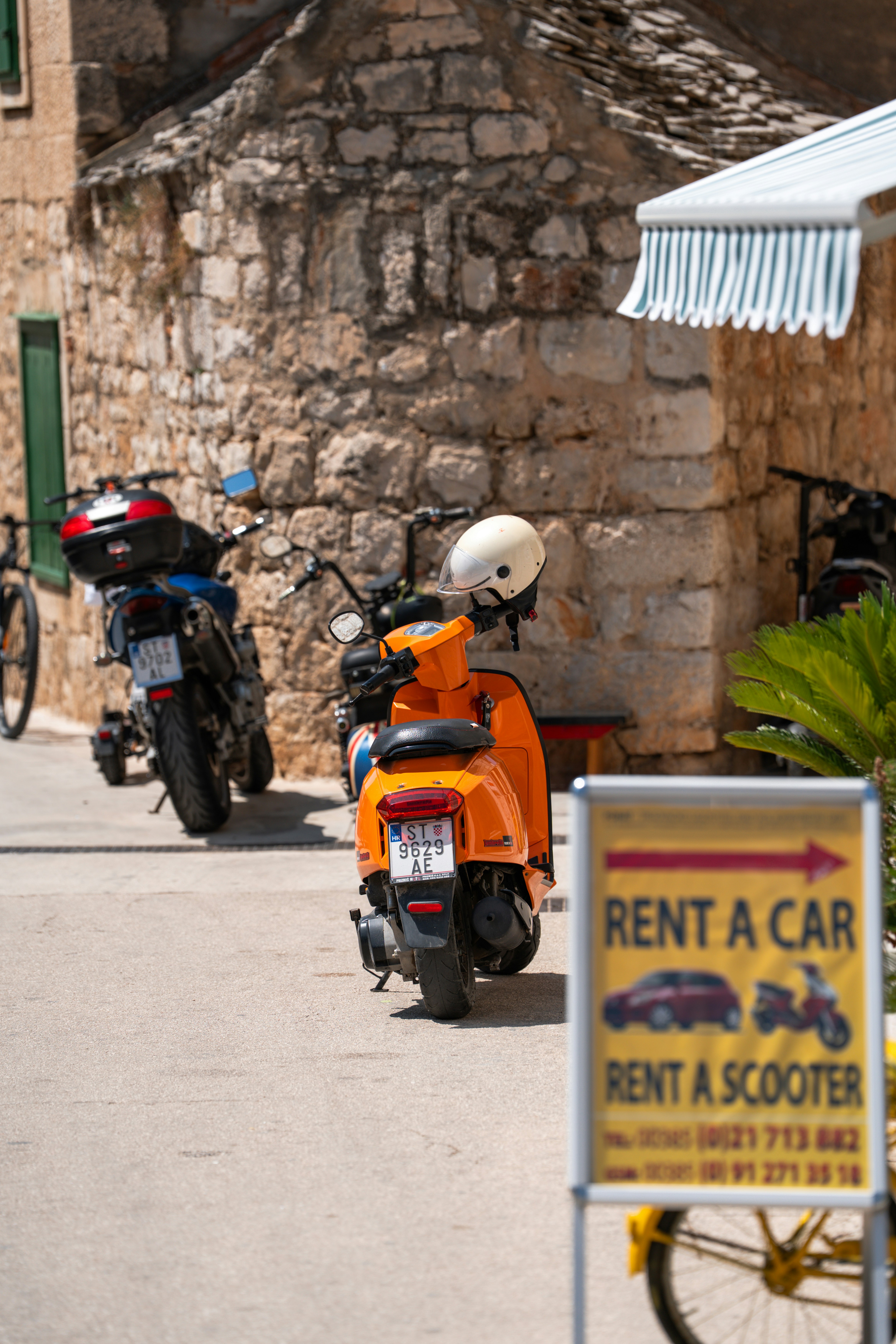 Orange Scooter in a Sunlit Courtyard