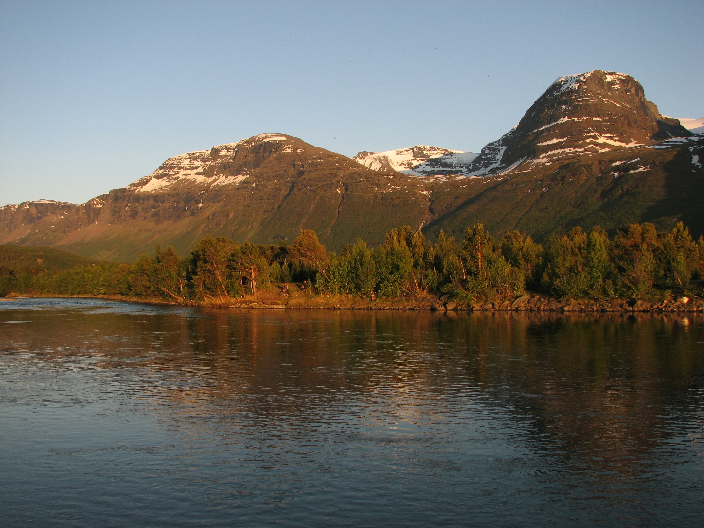 Sunlit Peaks Over a Calm River