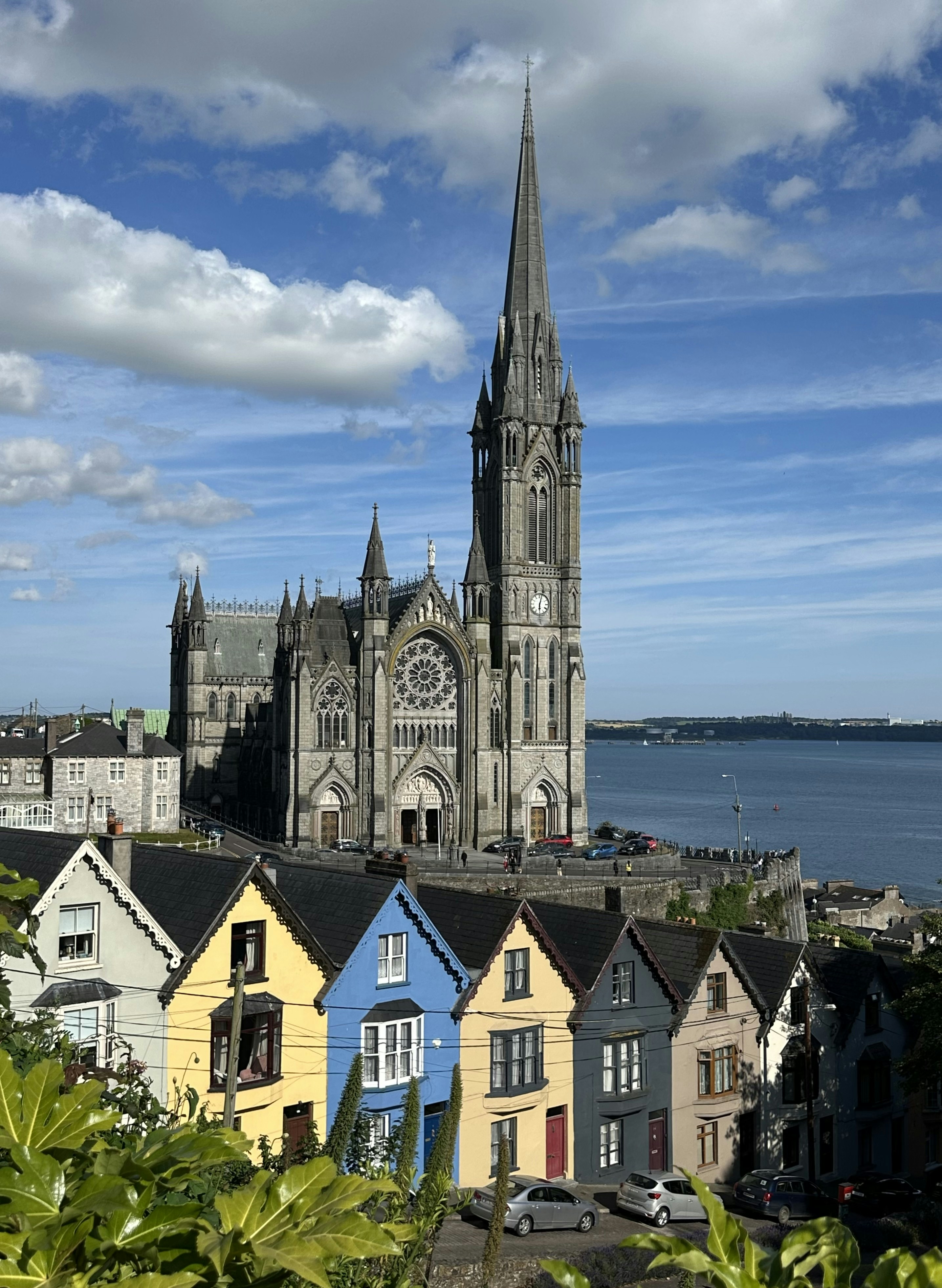 Stained roofs and a Gothic silhouette against a seaward horizon