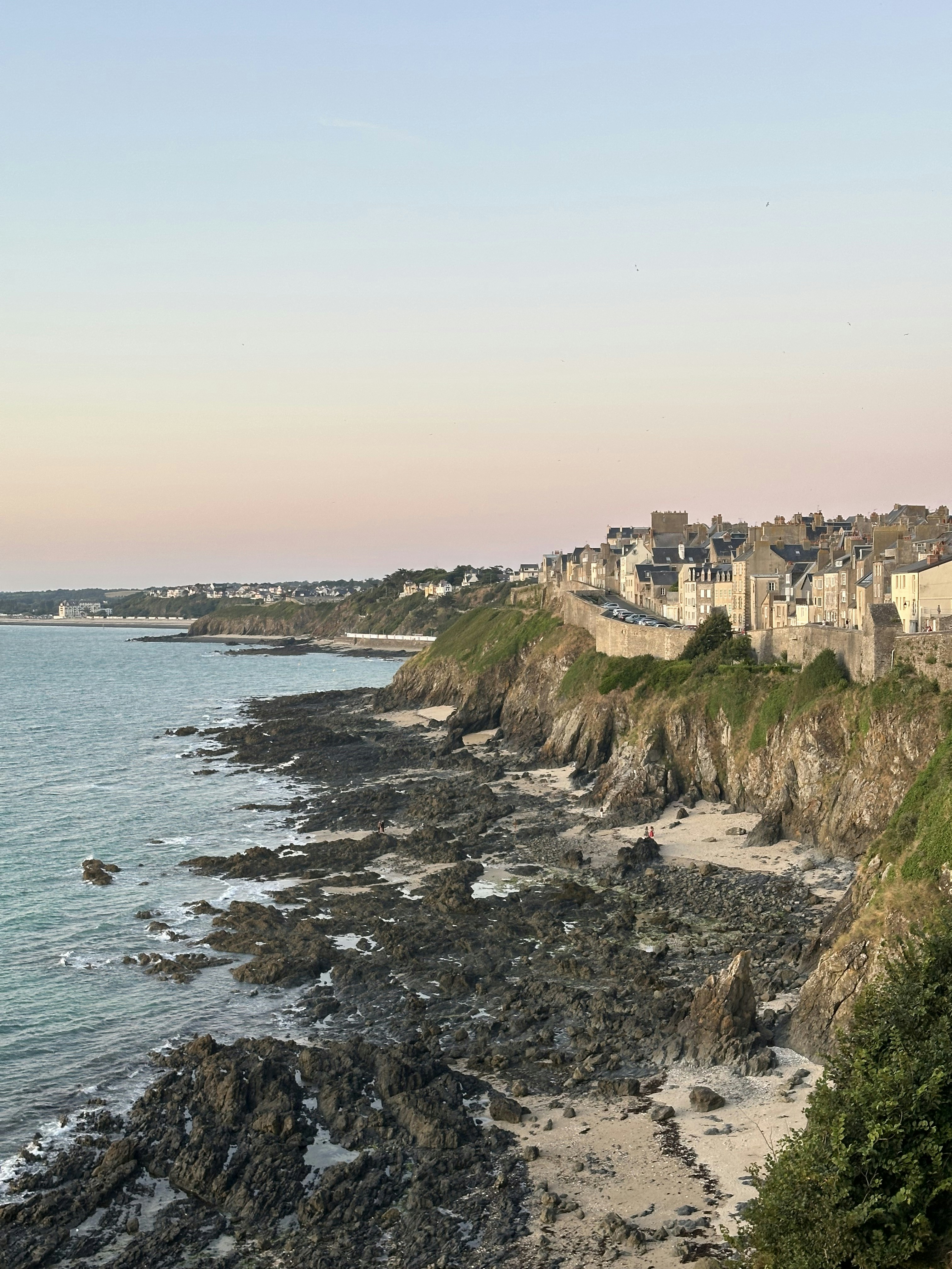Clifftop Village at Sea: A Sunset Over the Shoreline